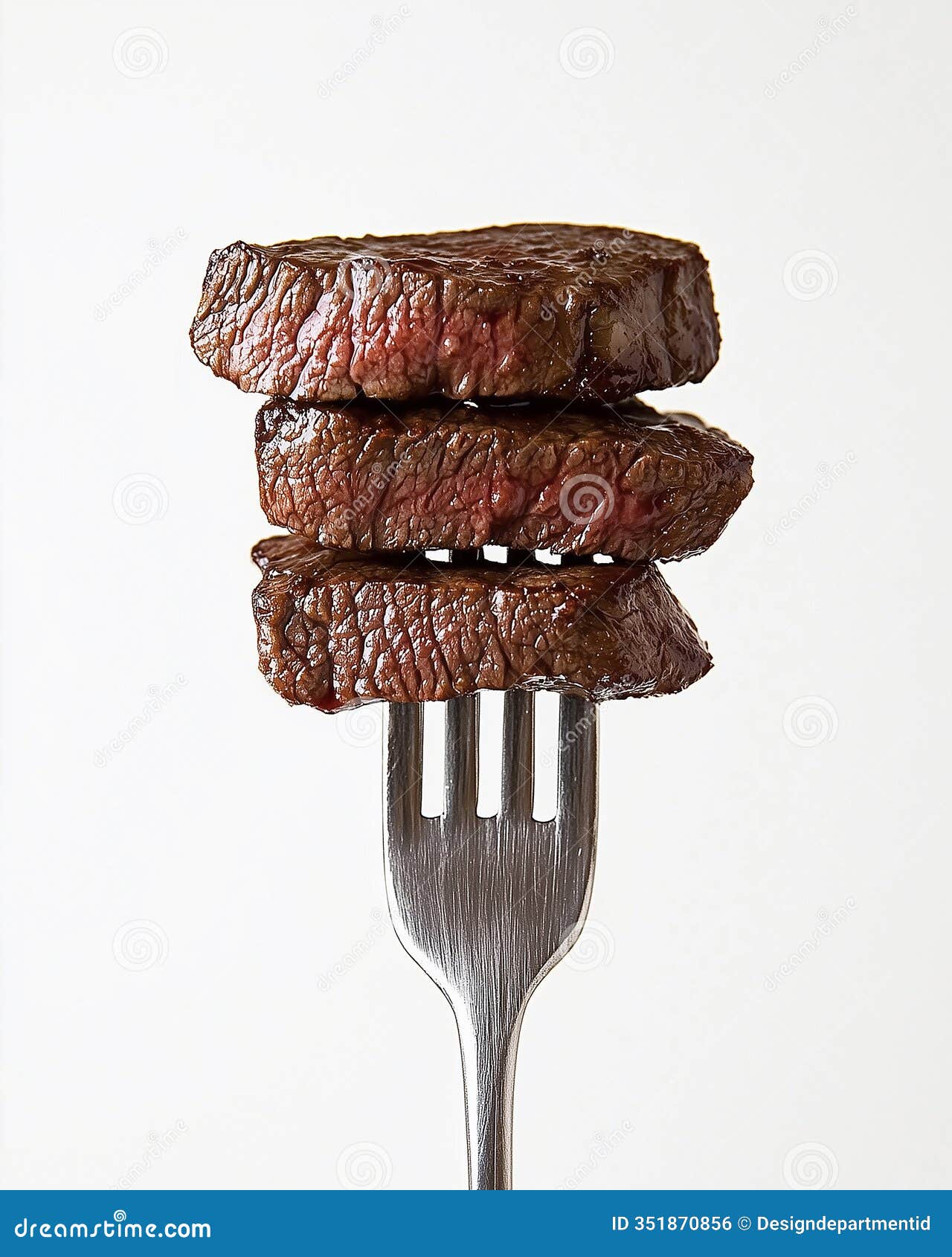 A Fork with Three Pieces of Steak Stacked on Top Stock Photo - Image of ...