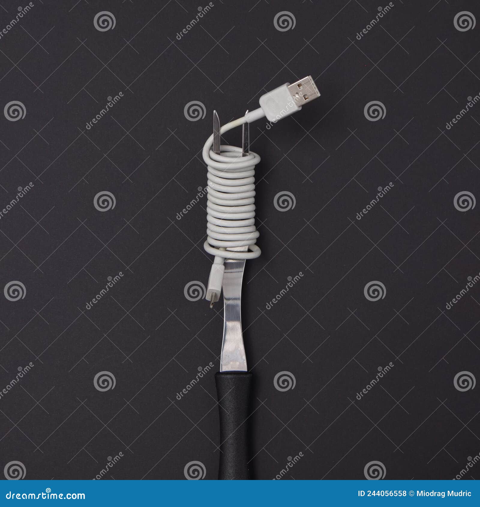 A Fork with a USB Cable Wrapped Like Spaghetti on a Black Background ...