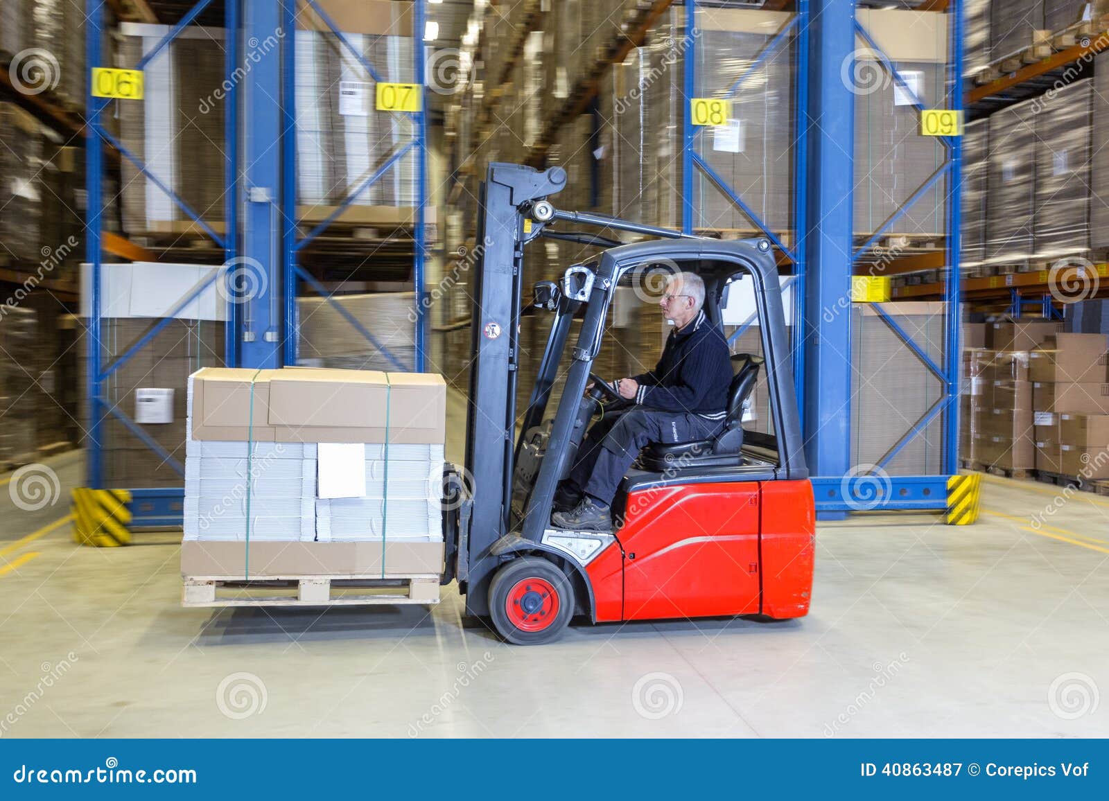 Forklift Driving Alongside a Storage Rack. Stock Image - Image of ...