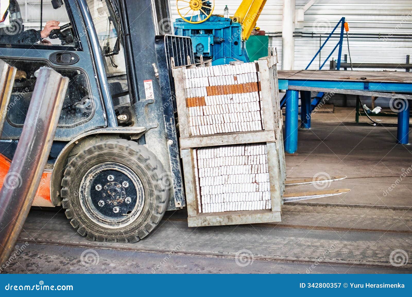 A Forklift Transporting a Heavy Load of Materials in an Industrial ...