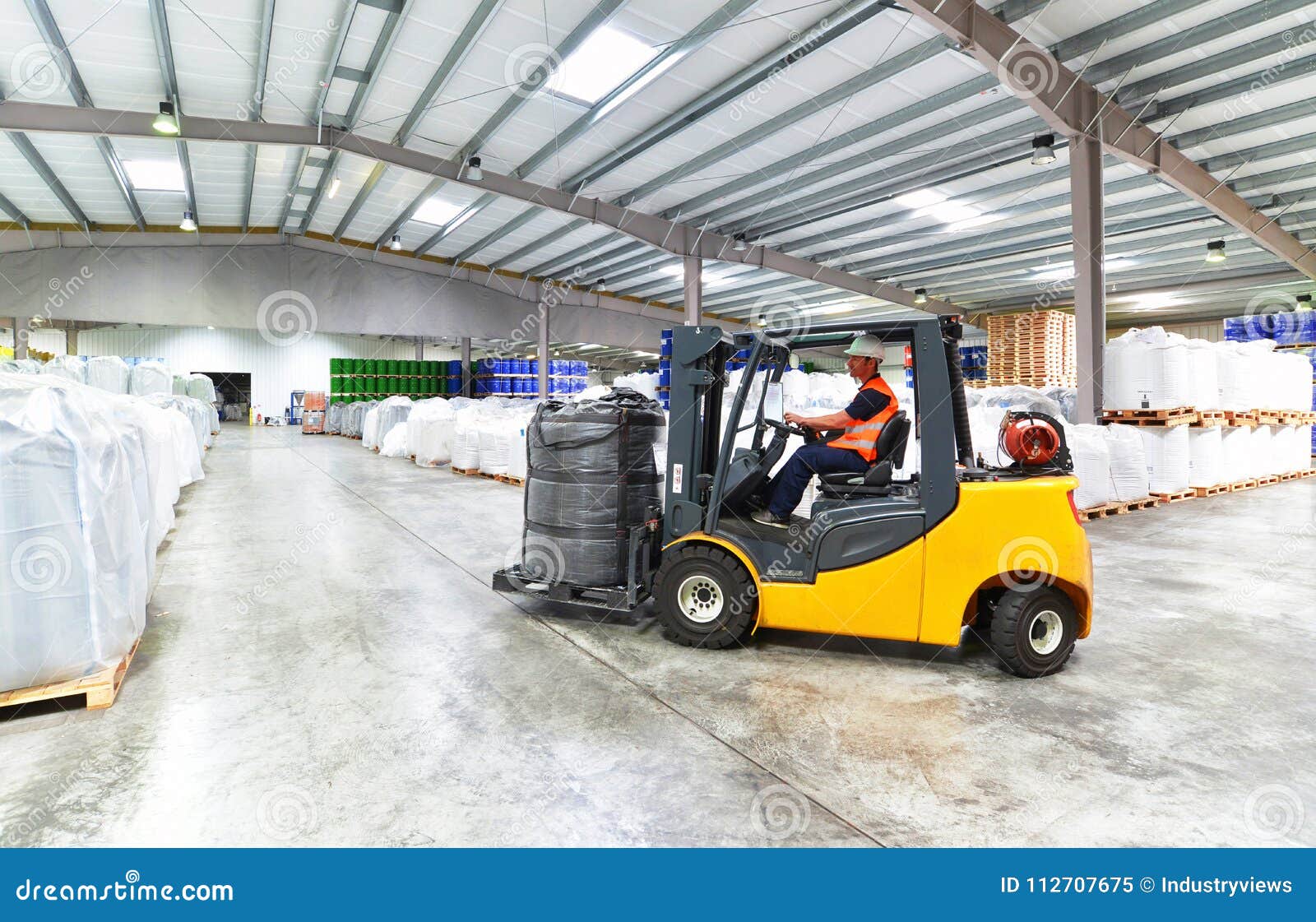 Forklift Trucks Transported in a Warehouse - Storage of Goods in Stock ...