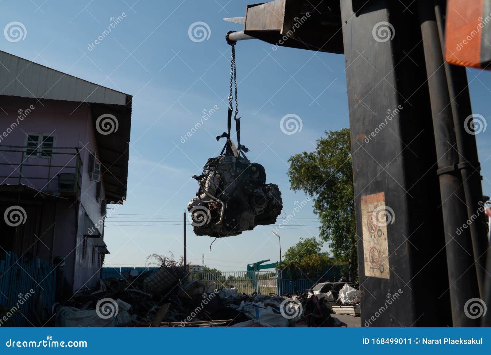 A Forklift and Workers are Lifting an Old Car`s Engine for Recycling ...
