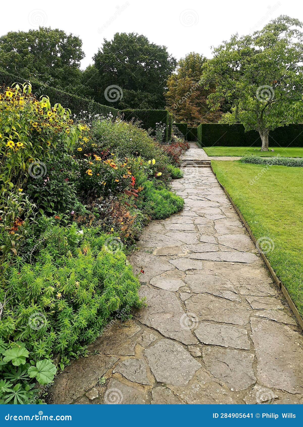 A Formal Garden with a Stone Path and a Long Border. Stock Image ...