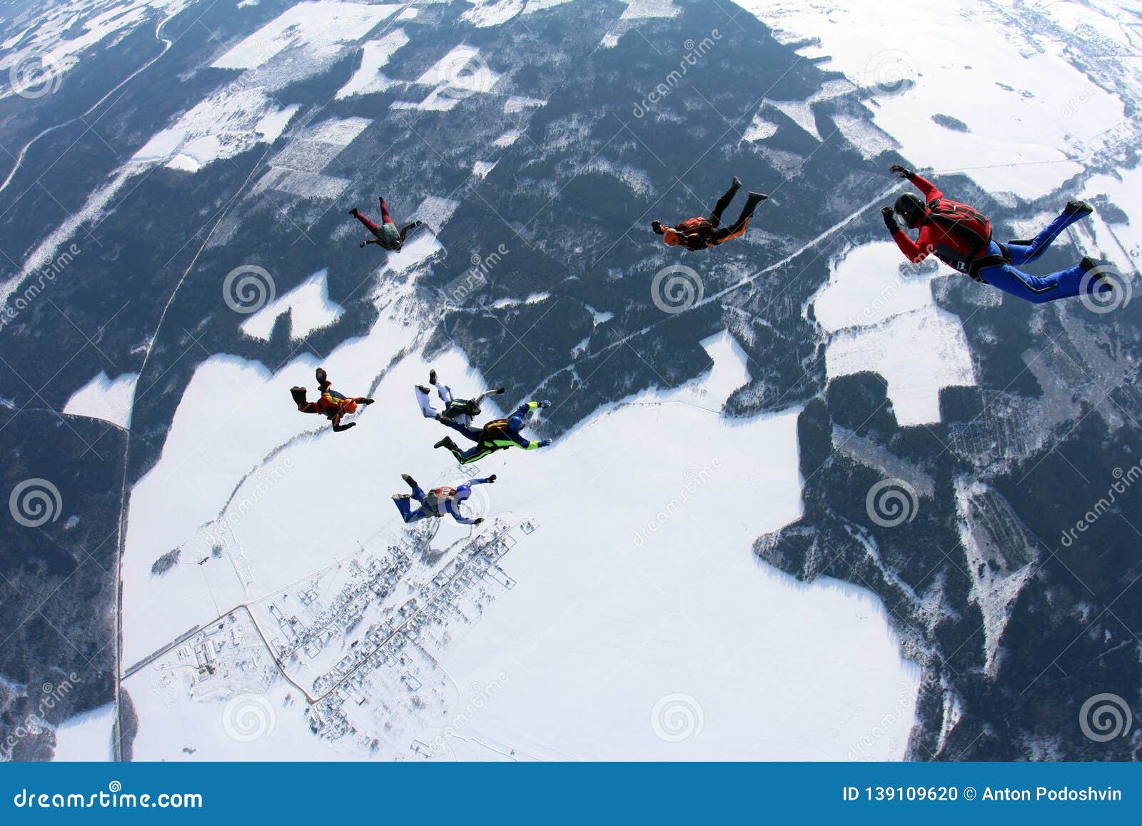 Formation Skydiving in the Winter Sky Above Snowy Fields. Editorial ...