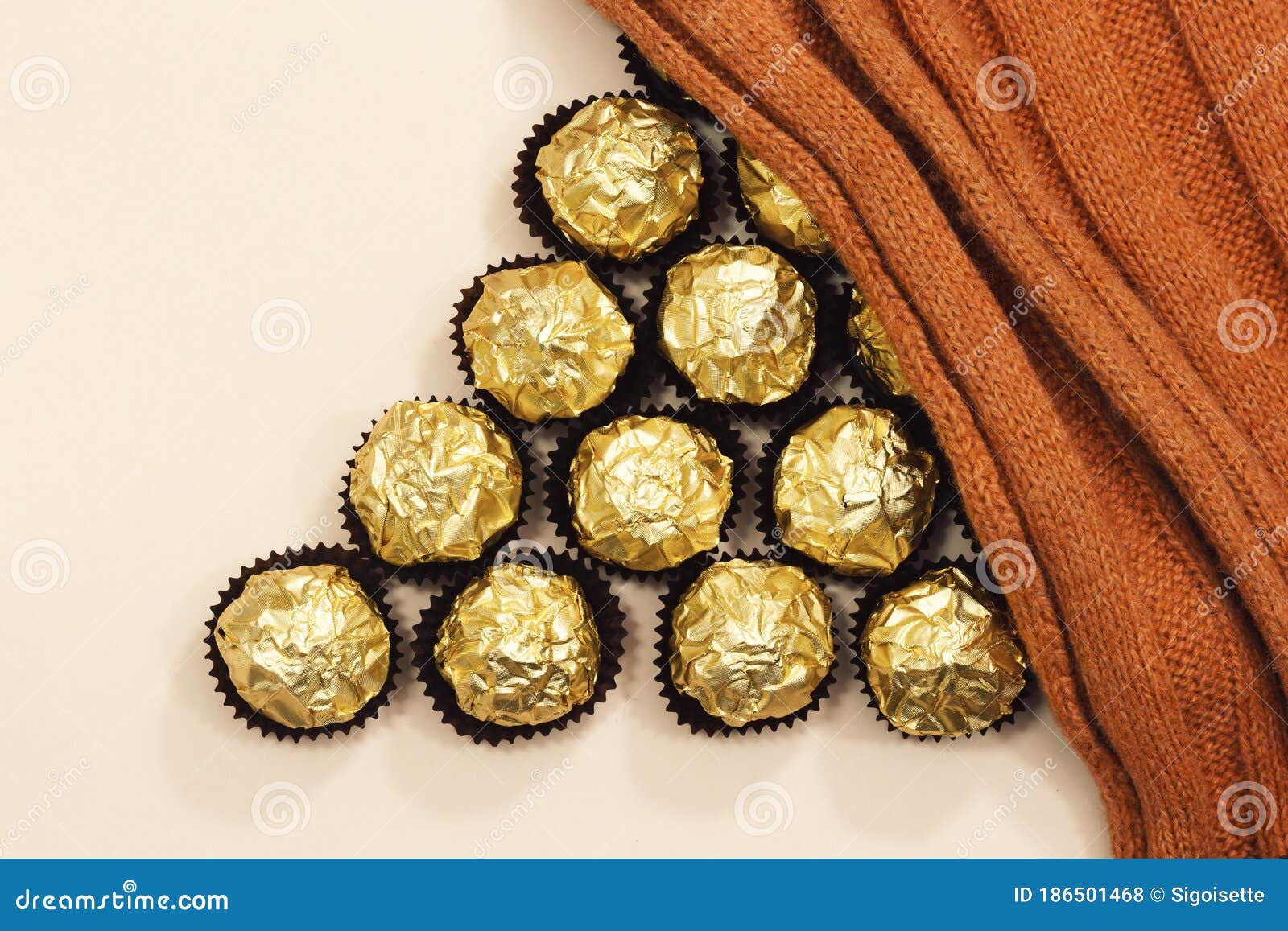 Forming Triangle Shape from Golden Premium Chocolate Sweets Under ...