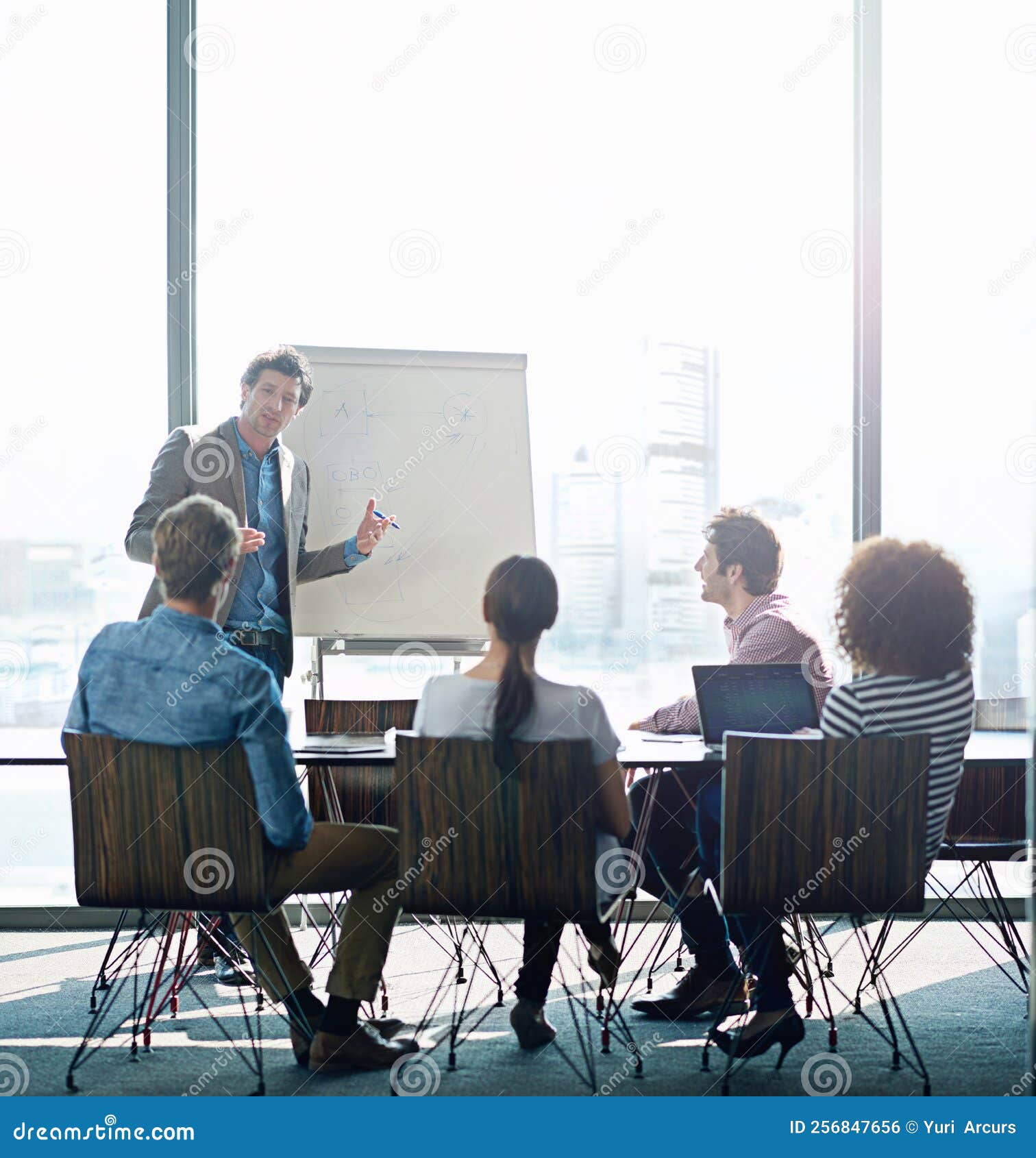 Formulating Ideas. a Group of Coworkers Sitting in on a Presentation in ...