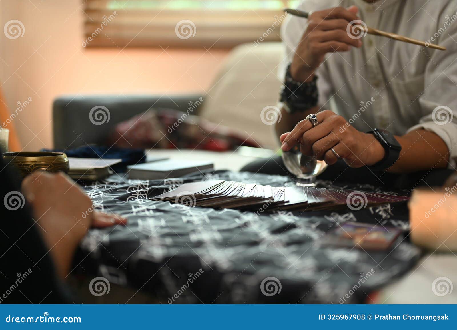 Fortune Teller during a Reading Session Talking To Client at Table with ...