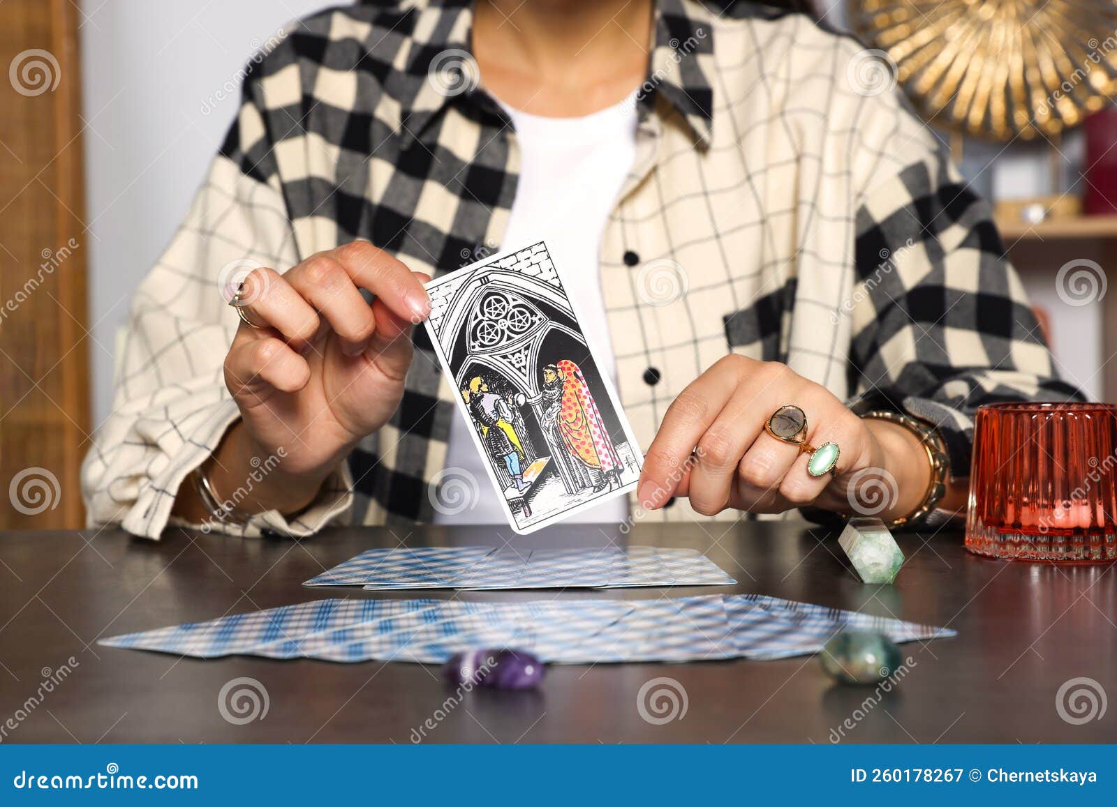 Fortune Teller with Tarot Card Three of Pentacles at Grey Table Indoors ...