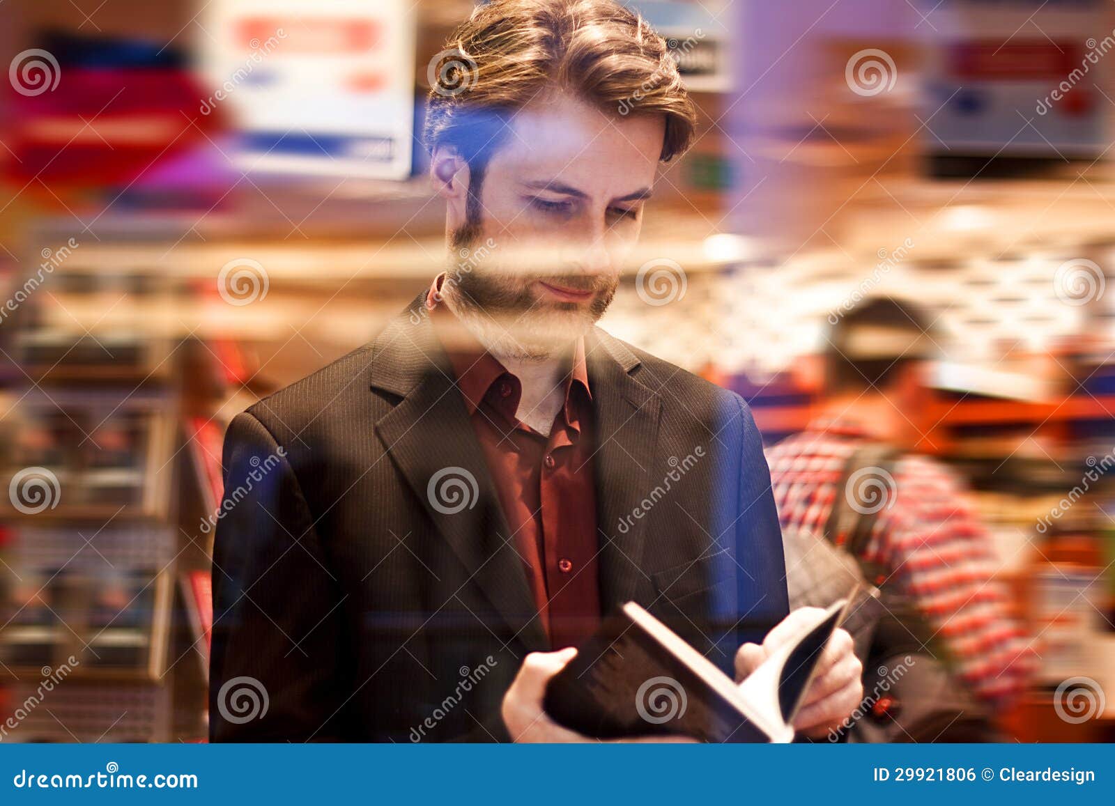 Elegant Man Standing Inside Bookstore Reading a Book Stock Photo ...