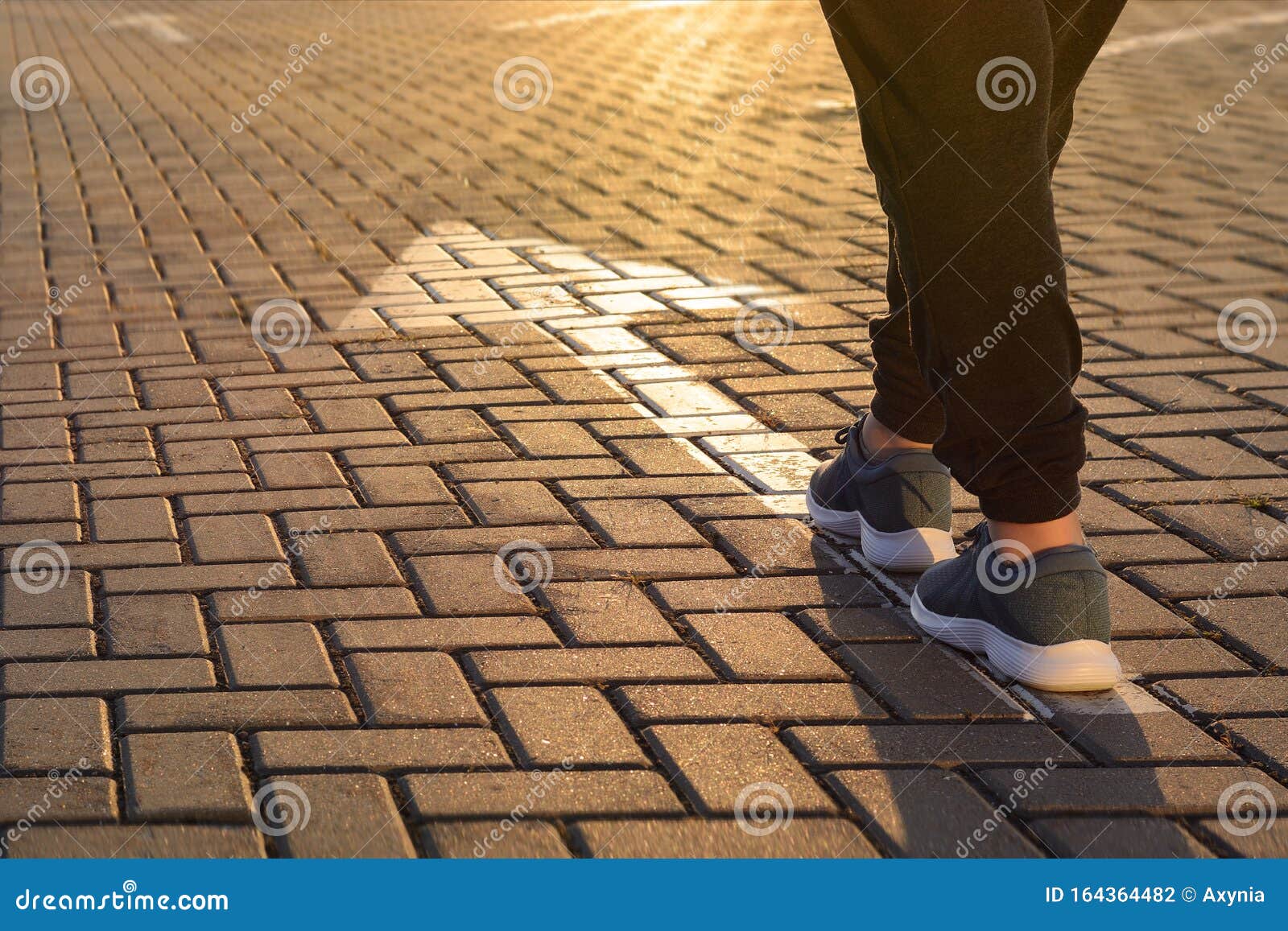 Forward Moving. Feet on Road Arrow in the Rays of Setting Sun Stock ...