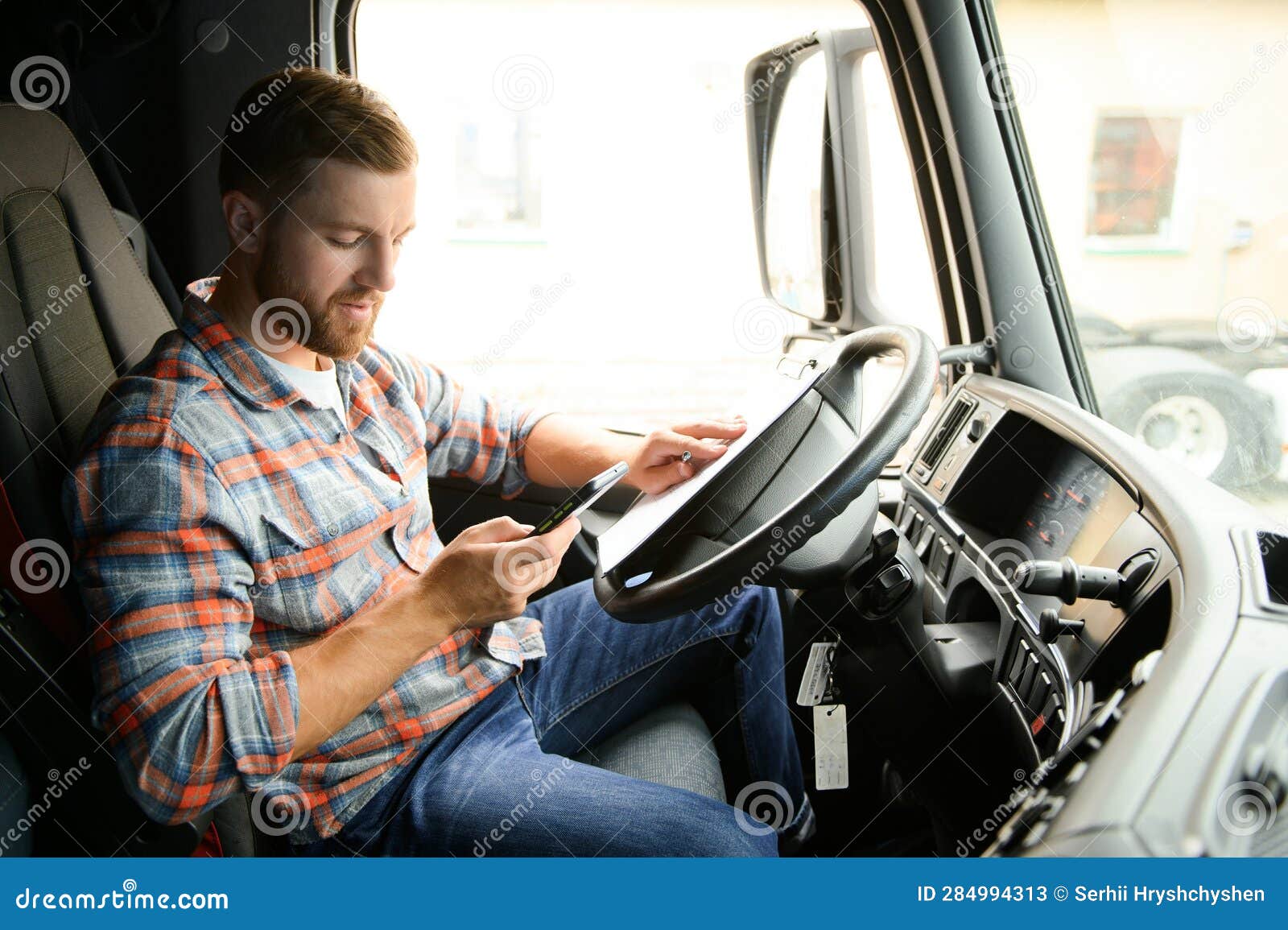 Forwarder Driver Sits Behind the Wheel of a Car and Examines Waybills ...