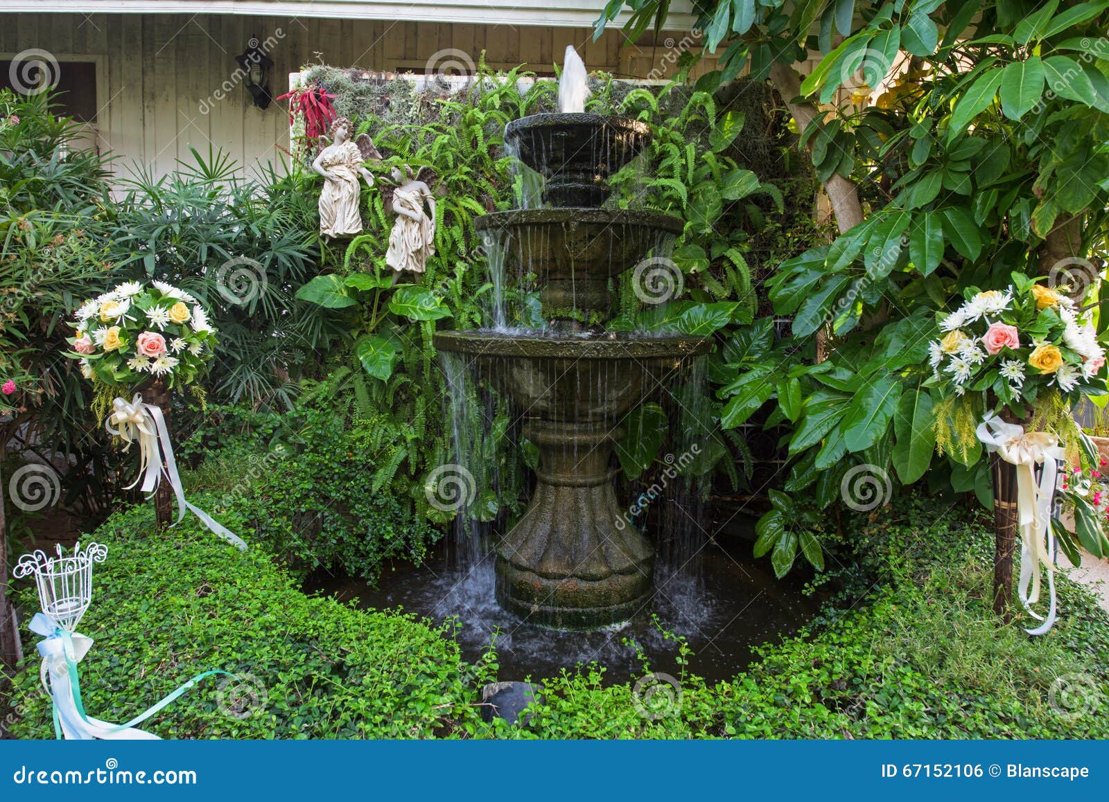 Fountain Multi-tiered and Flower Bouquet in Garden Stock Photo - Image ...