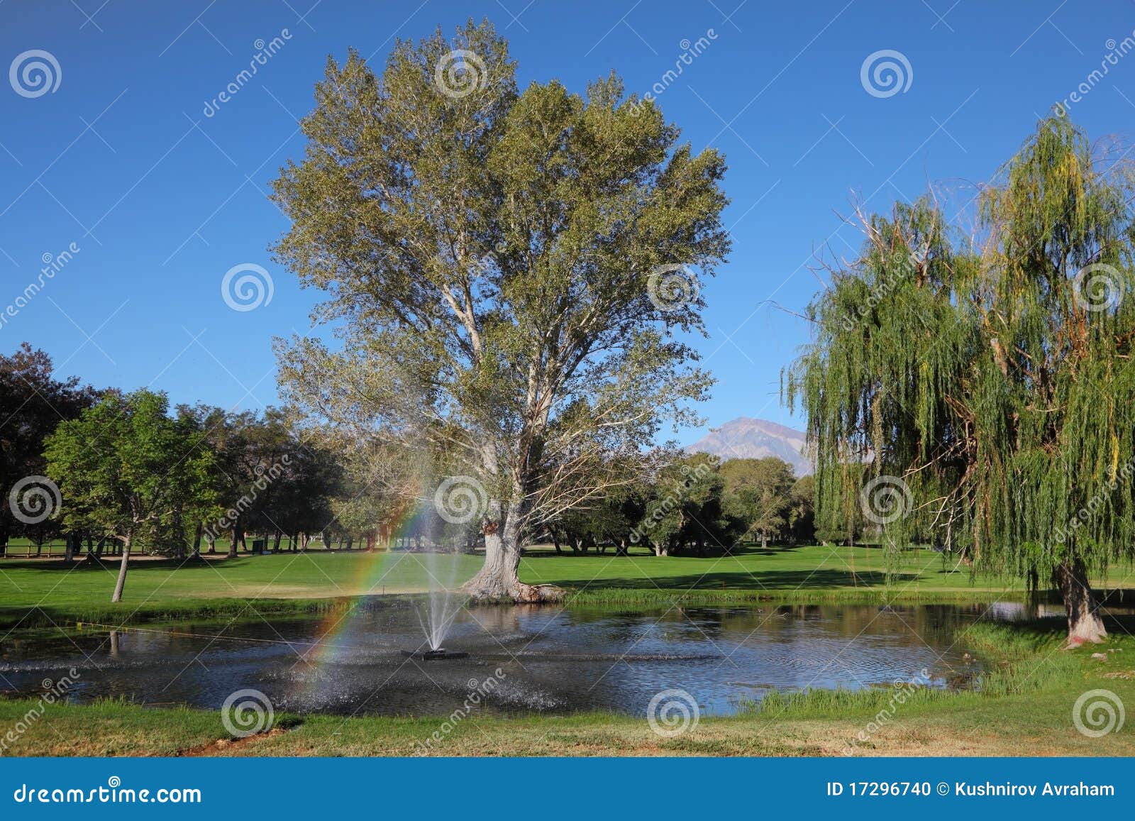 The fountain and trees stock photo. Image of rainbow - 17296740