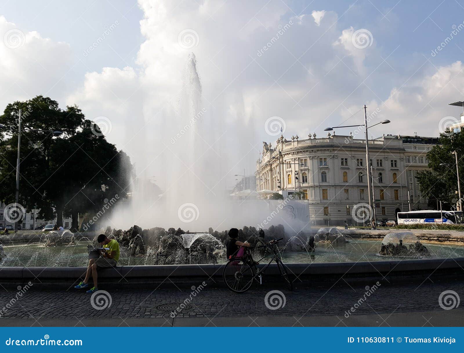 A Fountain with Two People Sitting Editorial Photo - Image of municipal ...
