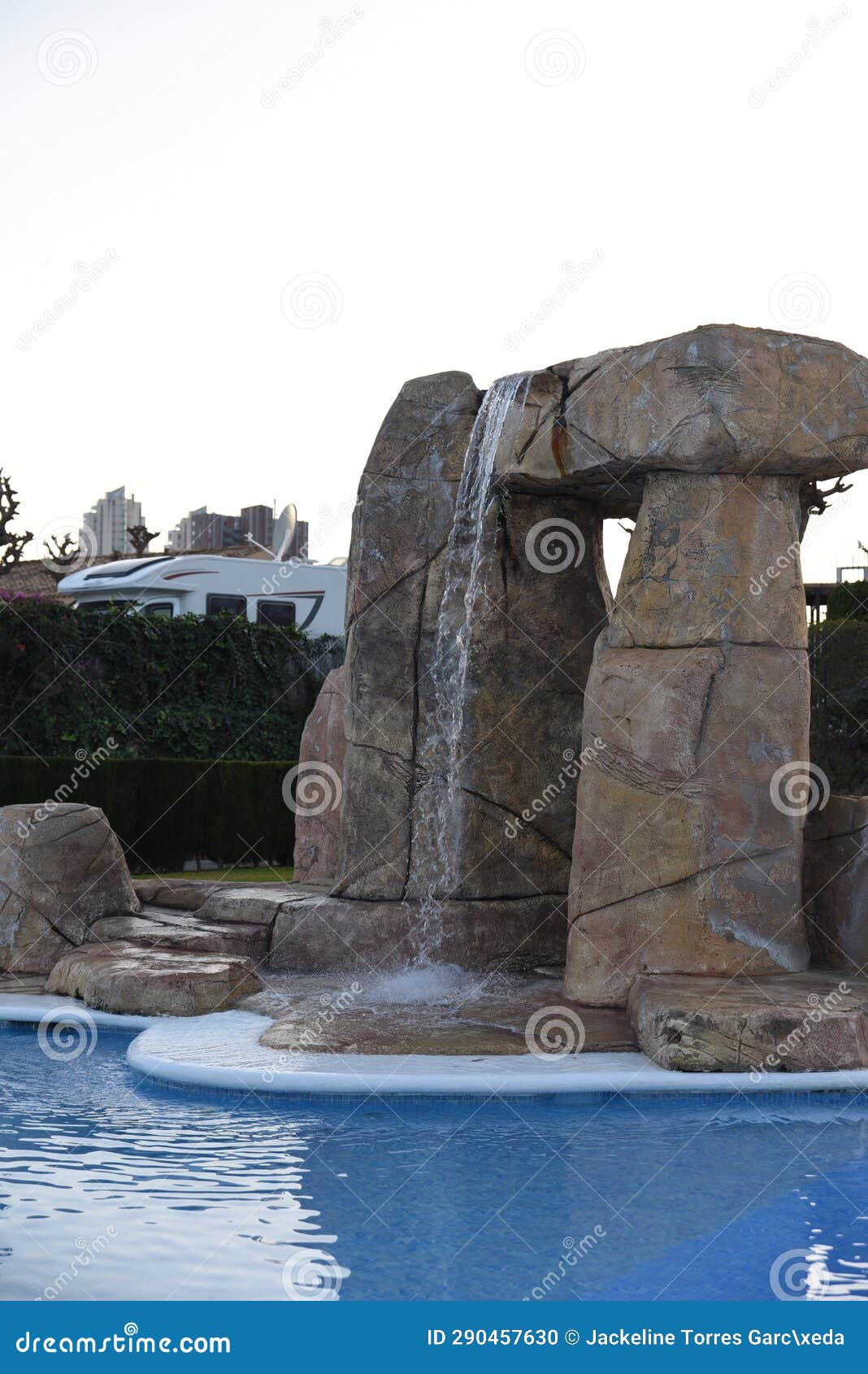 Fountain of Water Falling Over a Stone in a Swimming Pool. Stock Photo ...