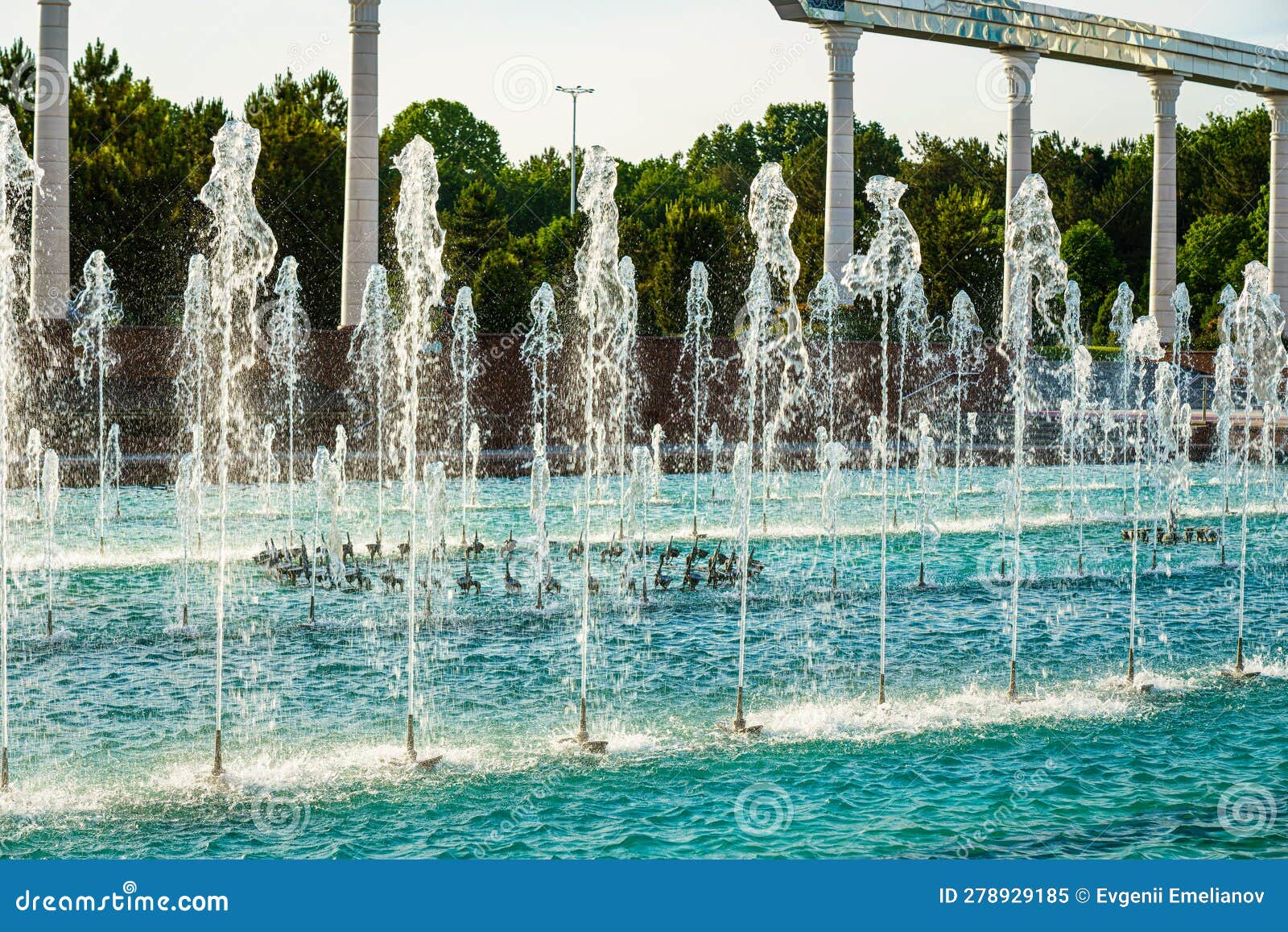 Fountains Illuminated by Sunlight at Sunset or Sunrise in the Park at ...