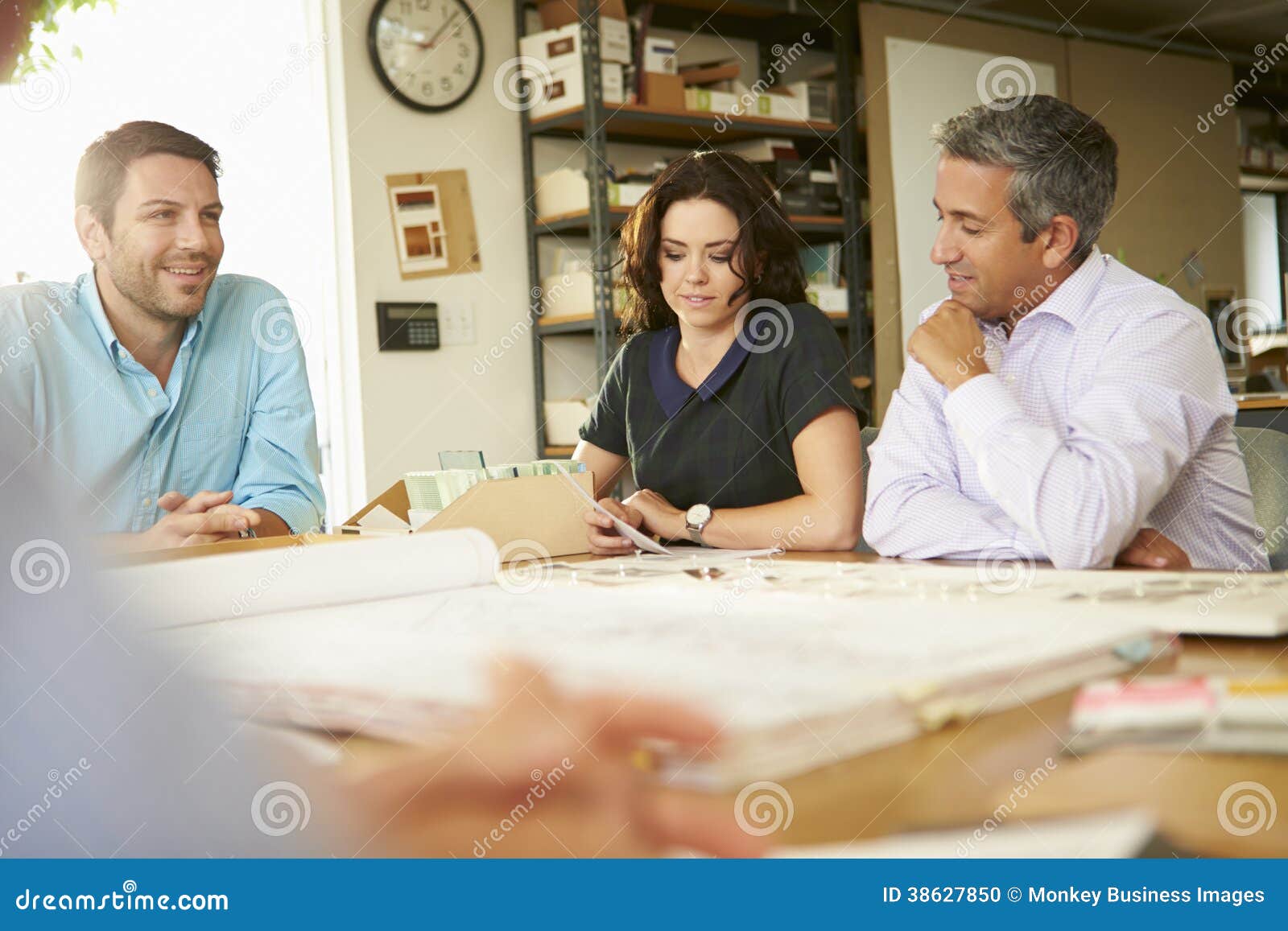 Four Architects Sitting Around Table Having Meeting Stock Photo - Image ...
