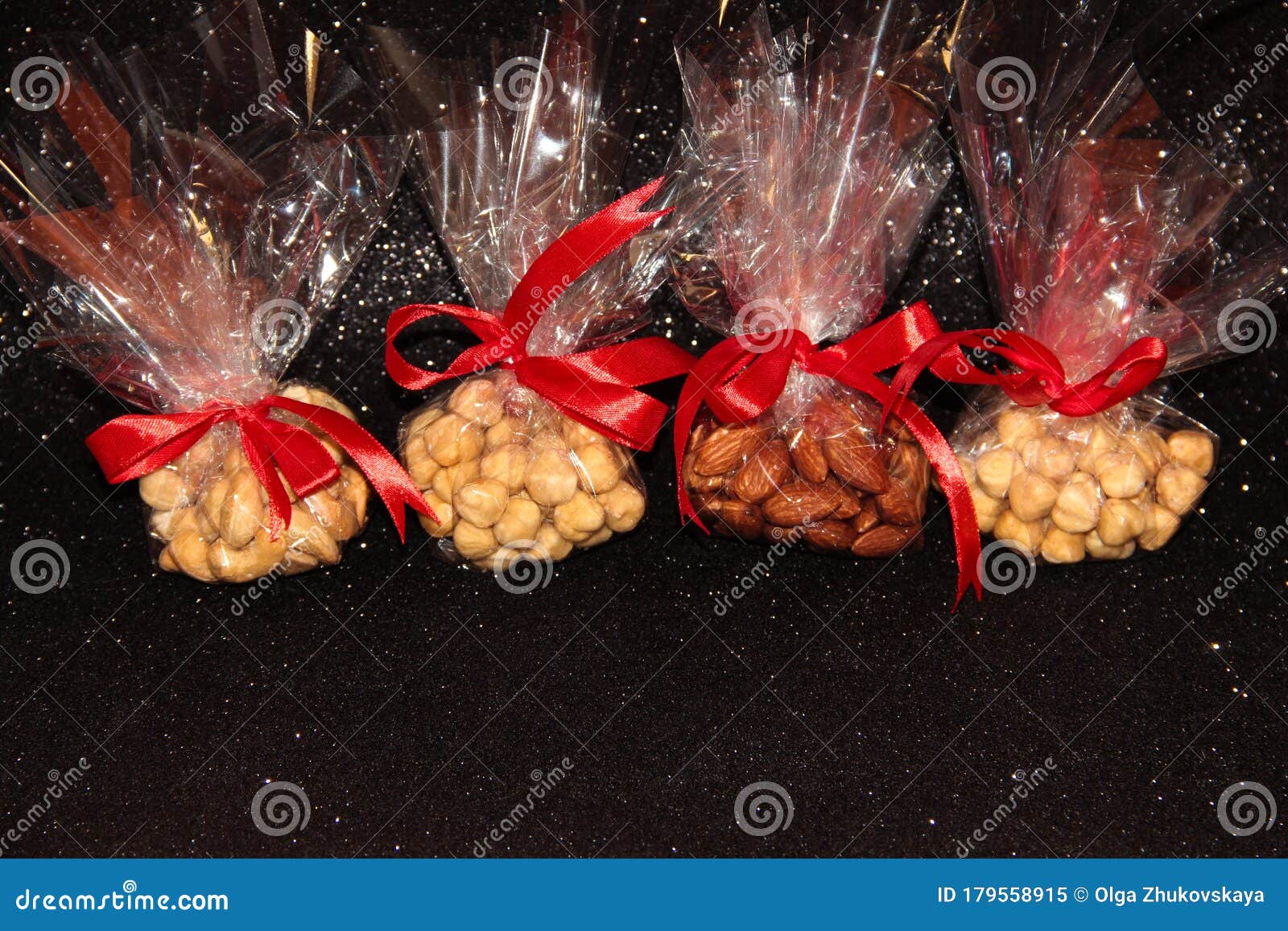 Four Bags of Nuts on a Black Background. Cashews, Almonds, and ...