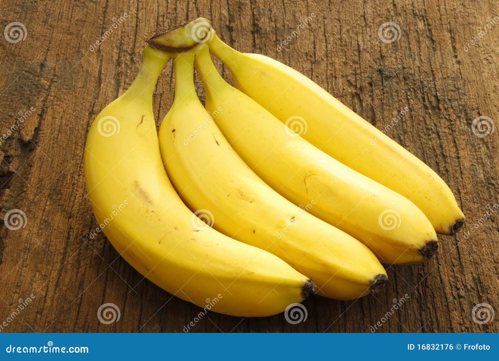 Four Bananas On Wooden Table Royalty-Free Stock Photo | CartoonDealer ...