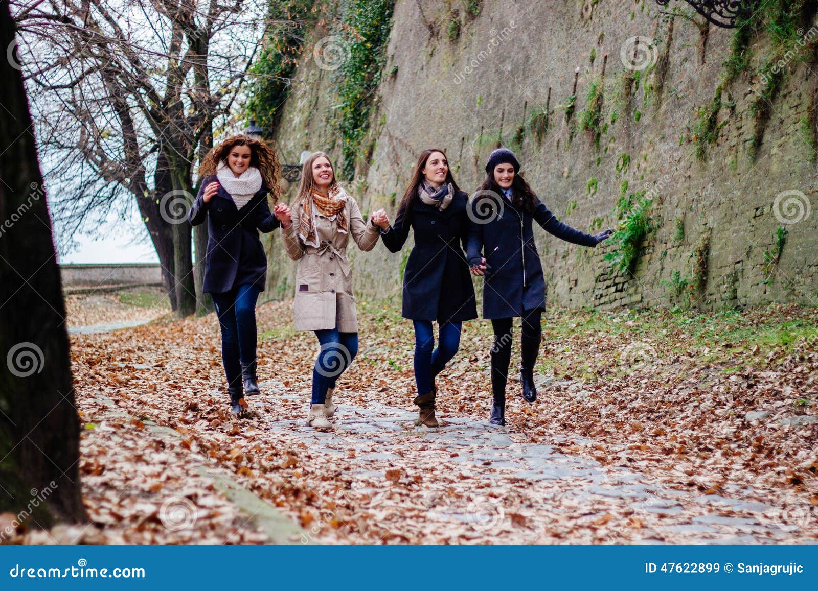 Four Beautiful Young Women Smiling and Walking Stock Image - Image of ...