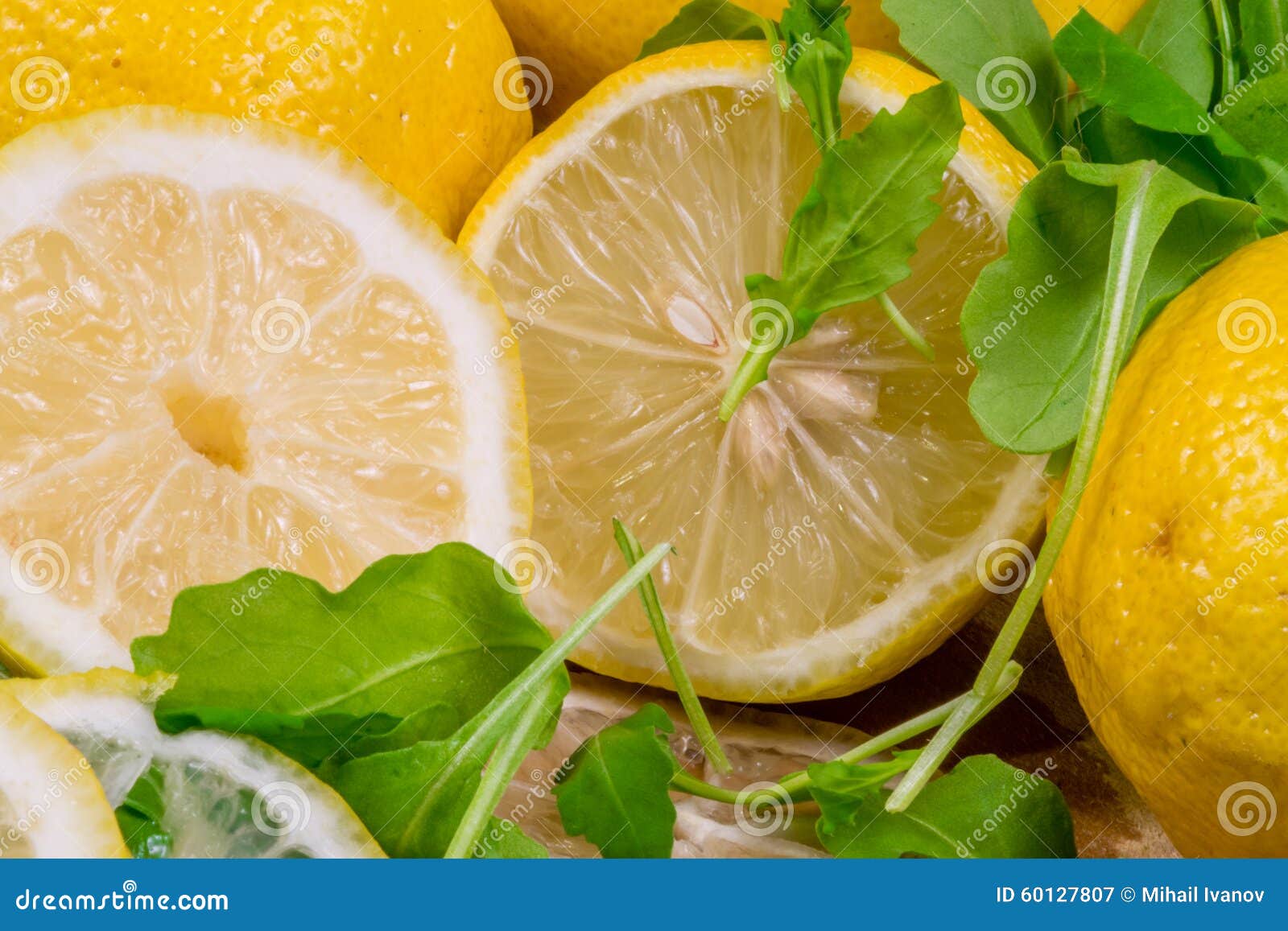 Four Beautifully Colored Lemons on a Canvas with Green Salad Stock ...
