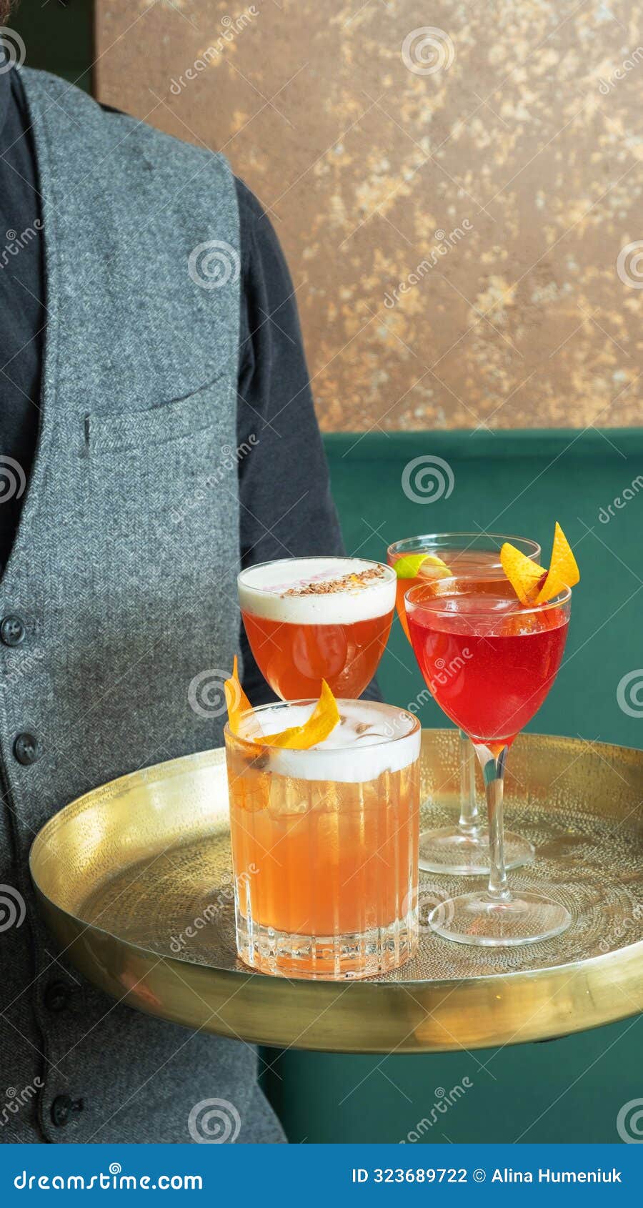 Four Bright Alcoholic Cocktails on Tray in Glasses in the Hands of ...