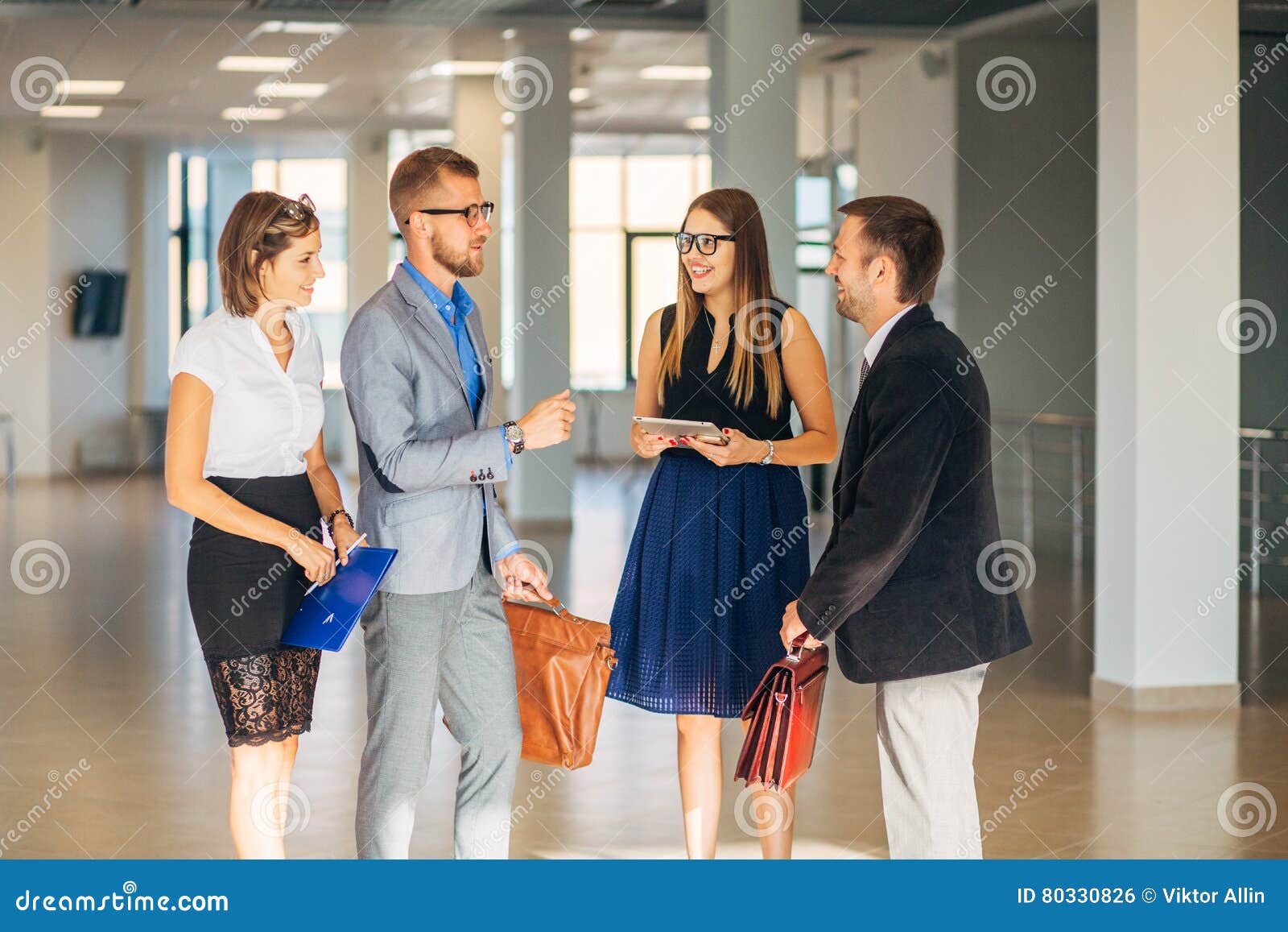 Four Business People Talking in Office Lobby Stock Photo - Image of ...
