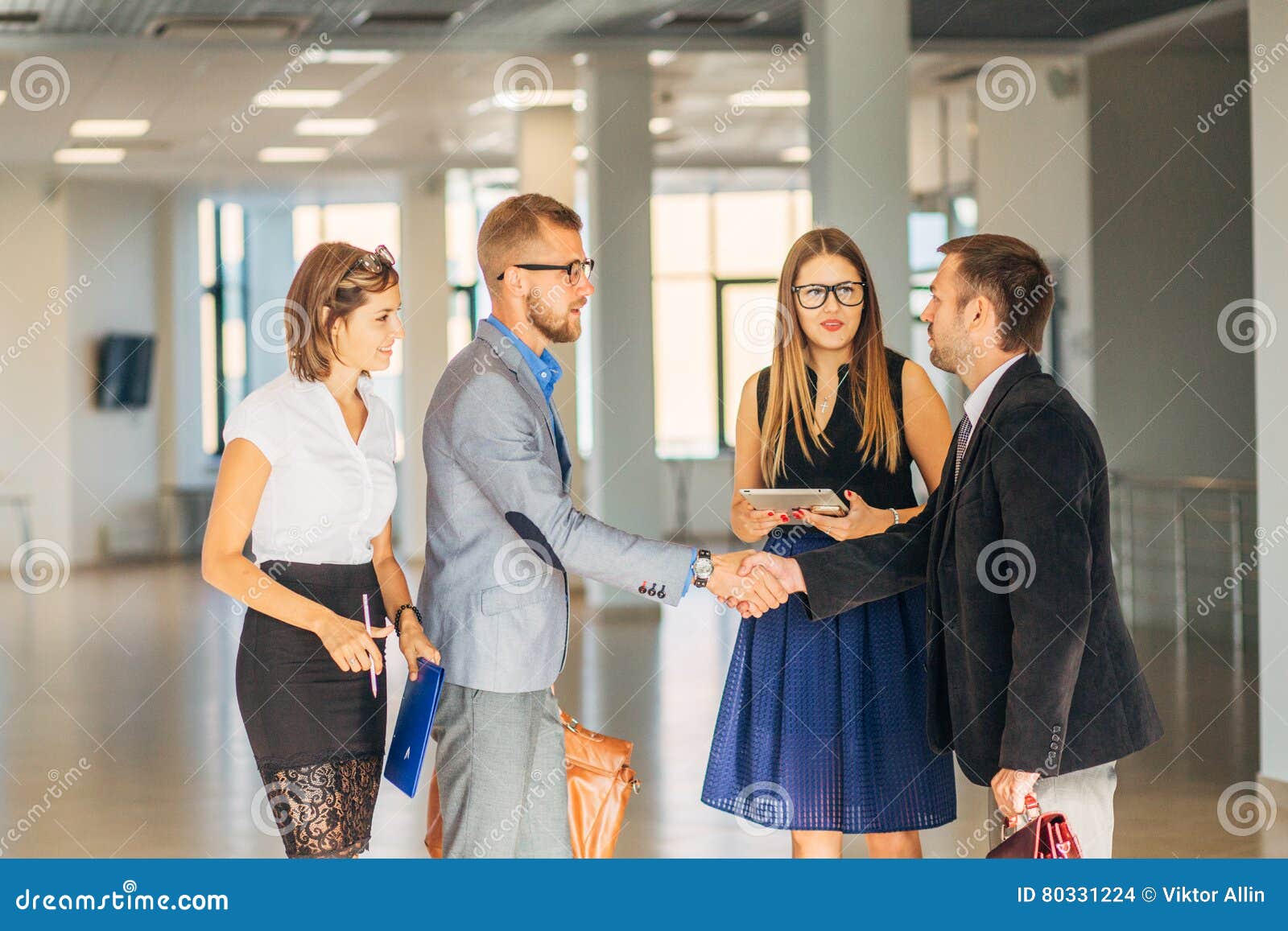 Four Business People Talking in Office Lobby Stock Photo - Image of ...