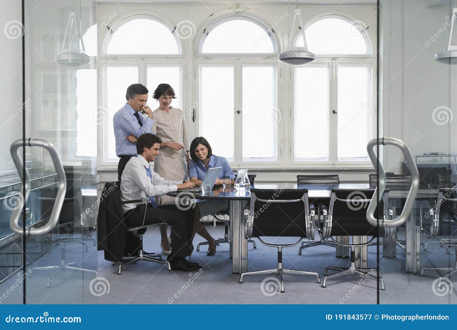 Four Business People Using Laptop in Office Stock Image - Image of ...