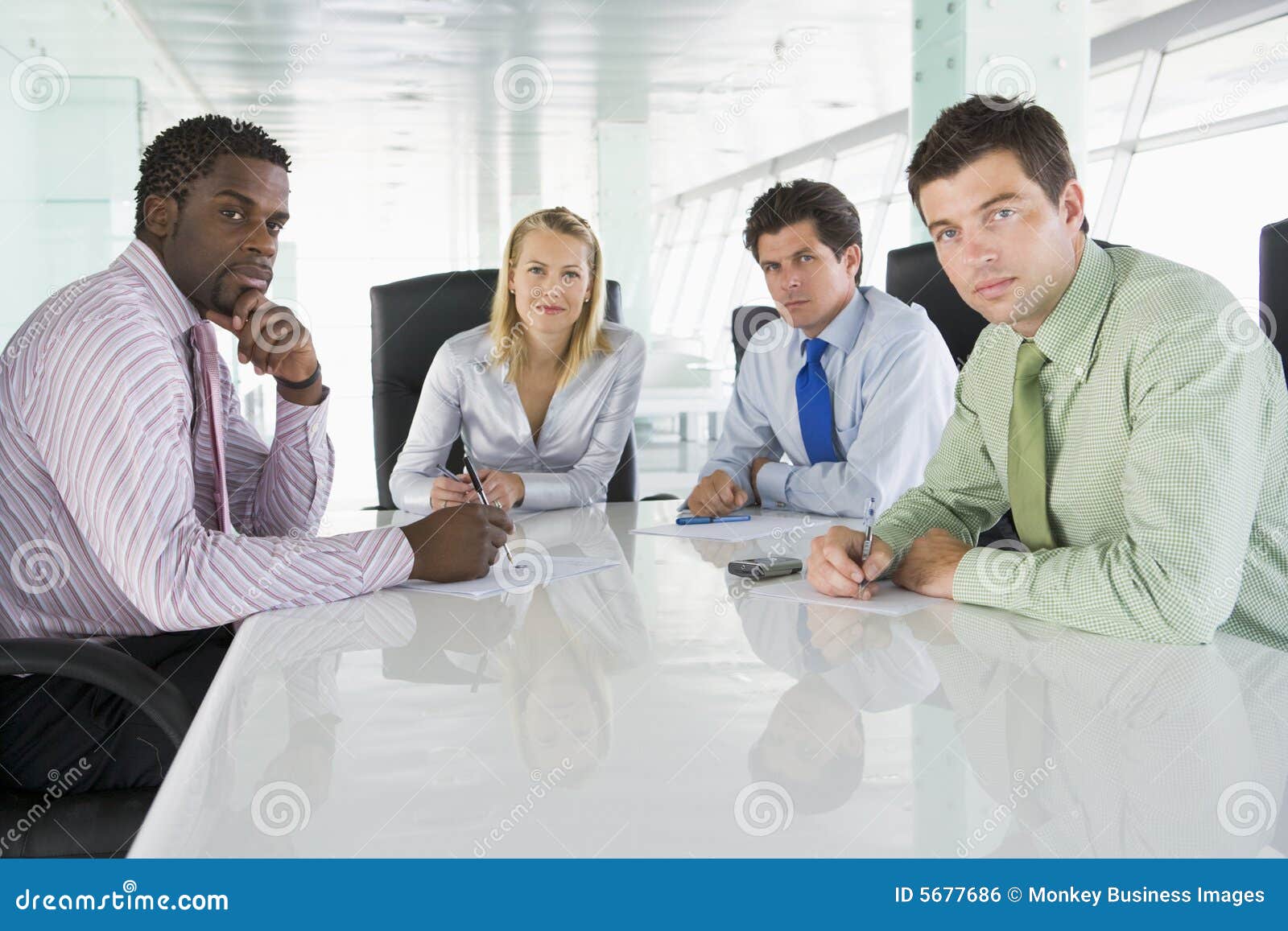 Four Businesspeople in a Boardroom Stock Photo - Image of boardroom ...