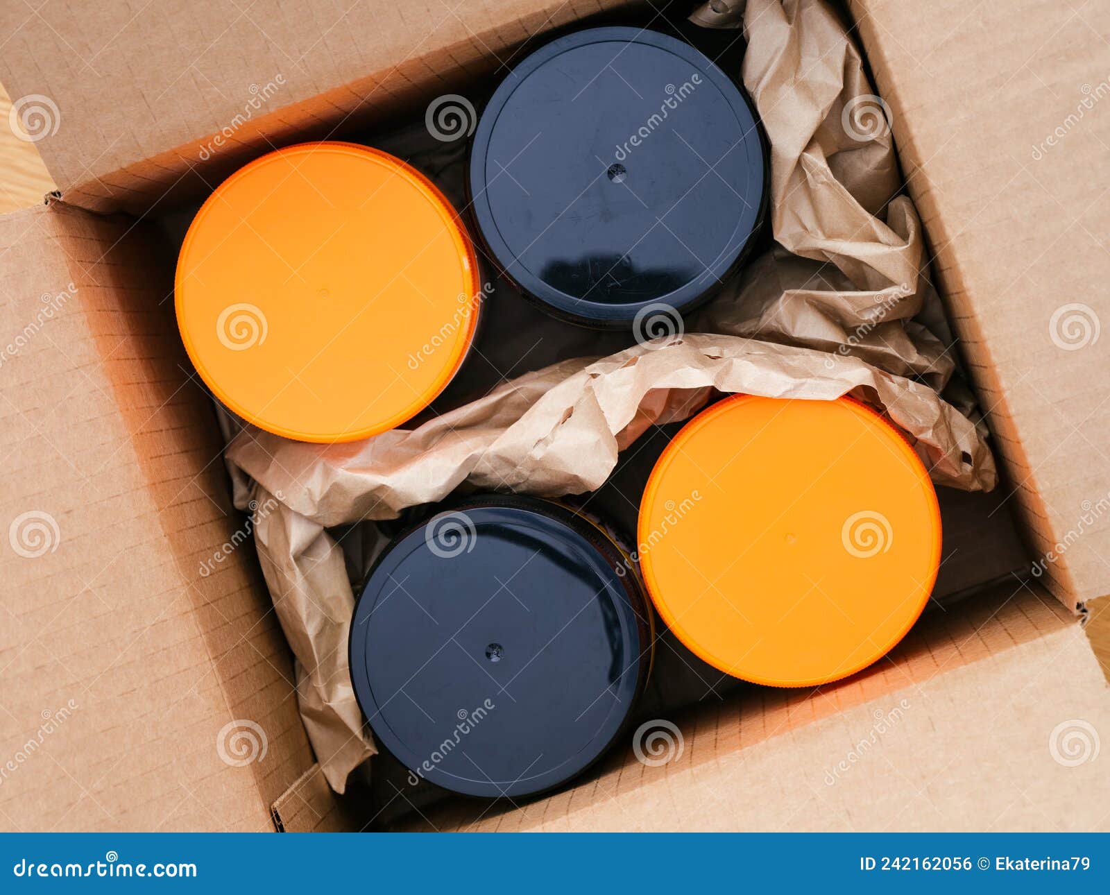 Four Cans in a Cardboard Box Stock Photo - Image of brown, yellow ...