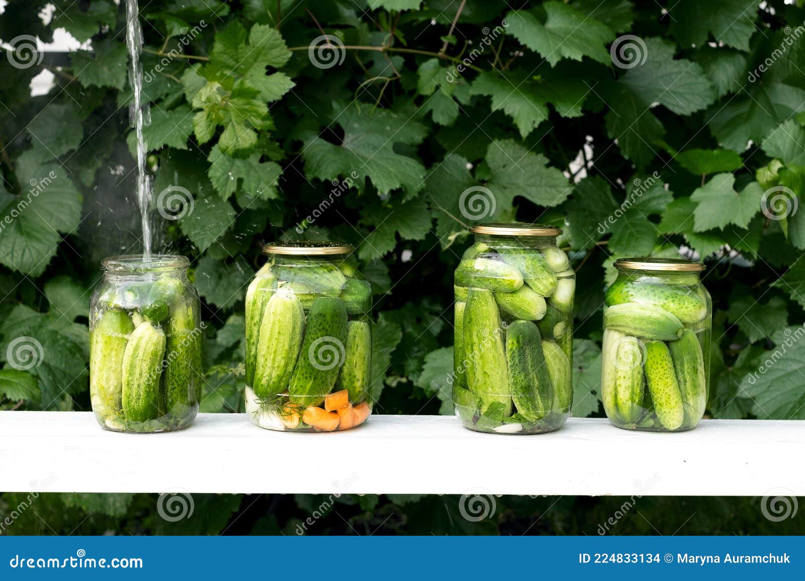 Four Cans of Fresh Cucumbers are Filled with Boiled Marinade Stock ...
