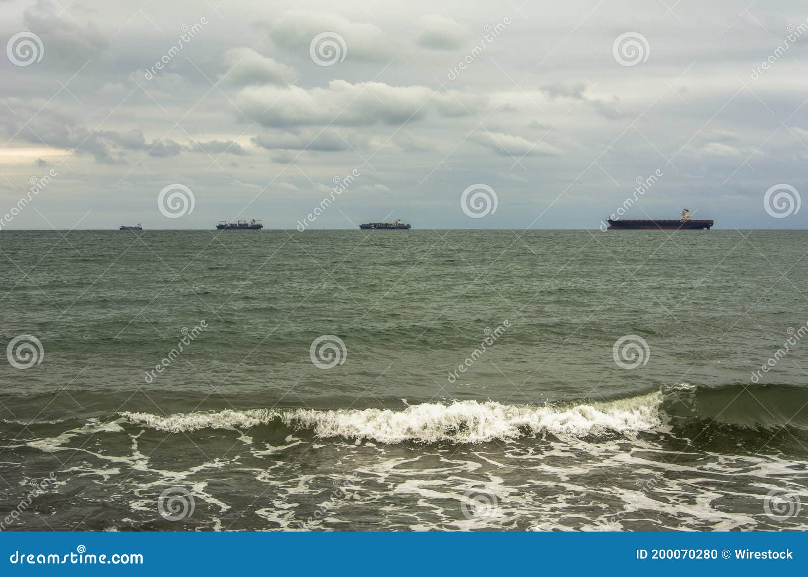 Four ships in the horizon stock photo. Image of shipping - 200070280