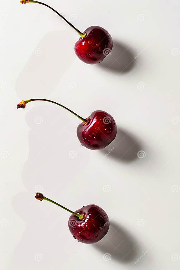 Four Cherries on a White Surface Stock Image - Image of white, surface ...