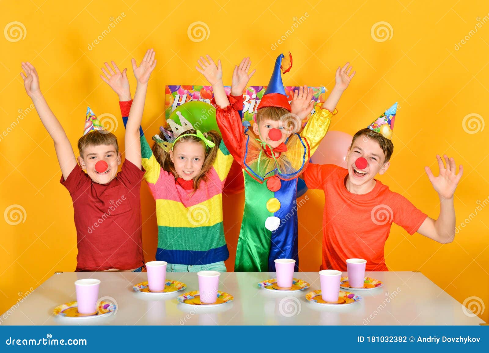 Four Children Celebrate a Birthday with a Clown at the Table Stock ...