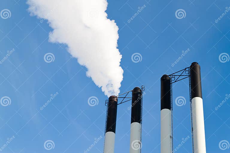 Four Chimneys on a Blue Sky Stock Photo - Image of pipe, industrial ...