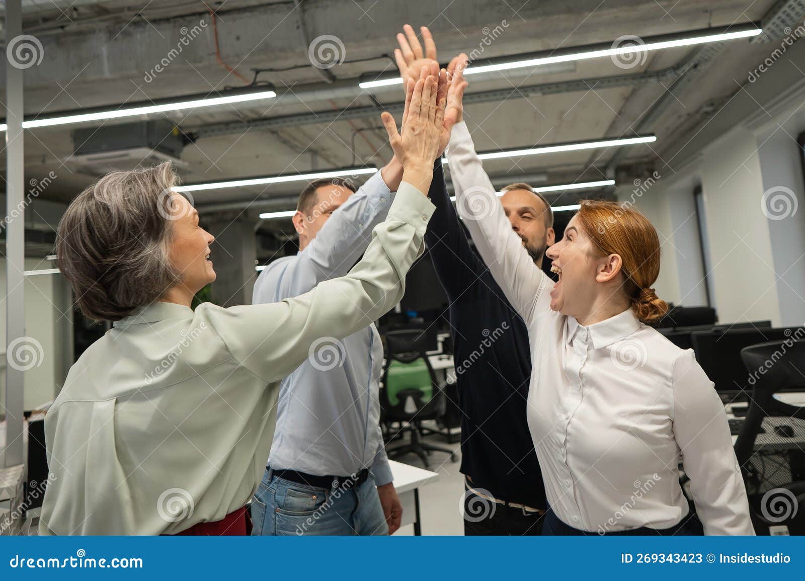 Four Co-workers Give a High Five in the Office. Stock Image - Image of ...