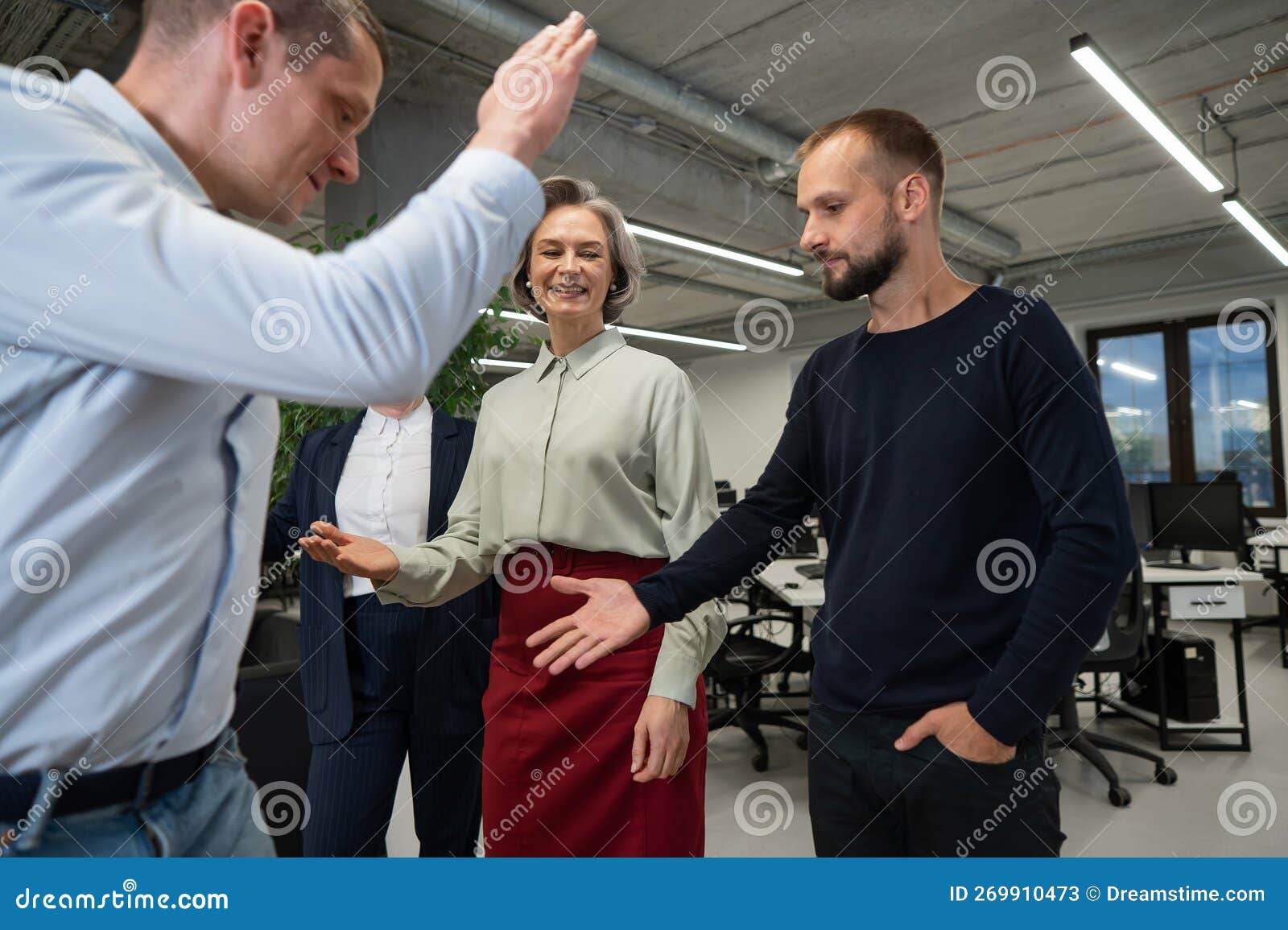 Four Co-workers Give a High Five in the Office. Stock Image - Image of ...