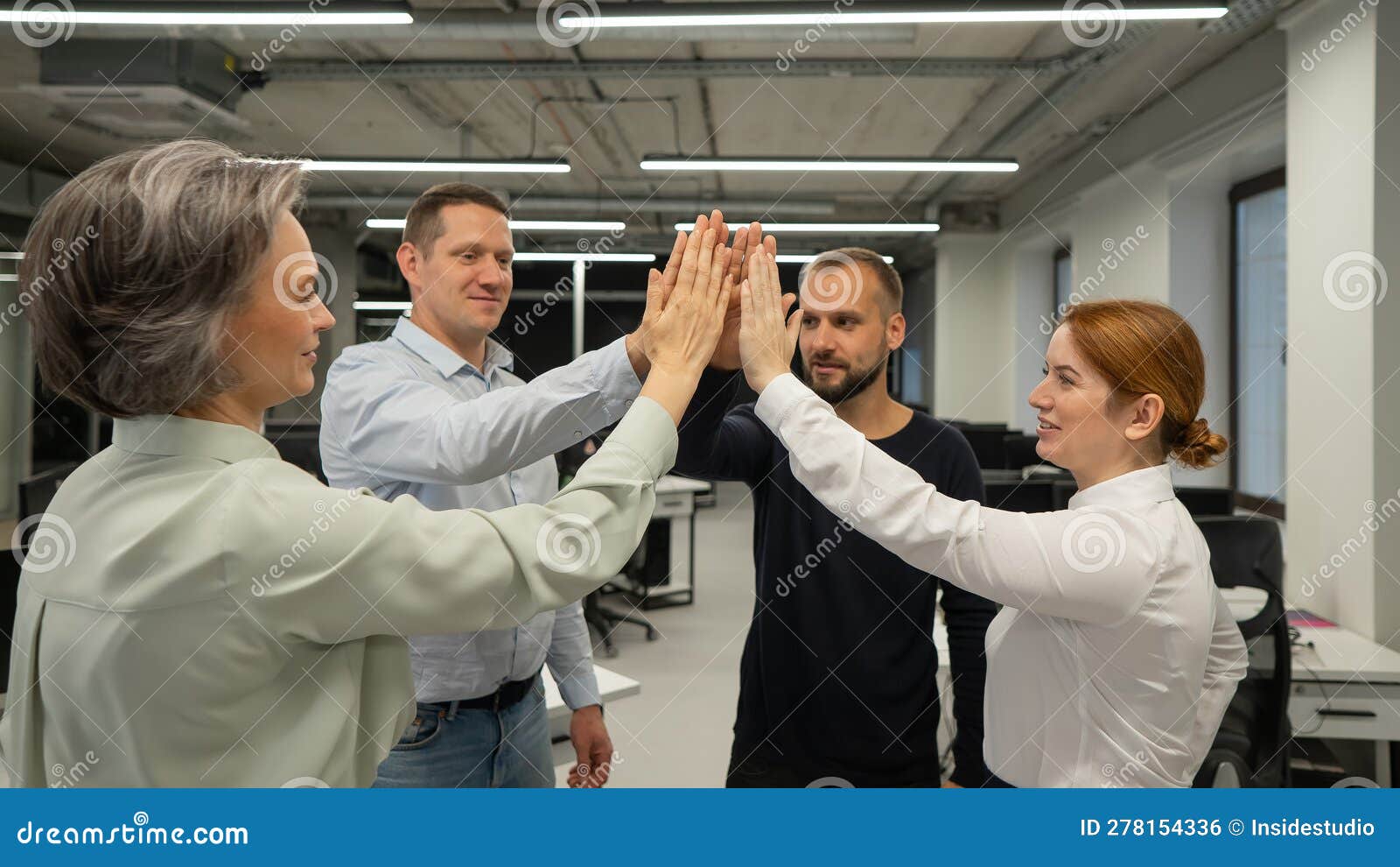 Four Co-workers Give a High Five in the Office. Stock Photo - Image of ...