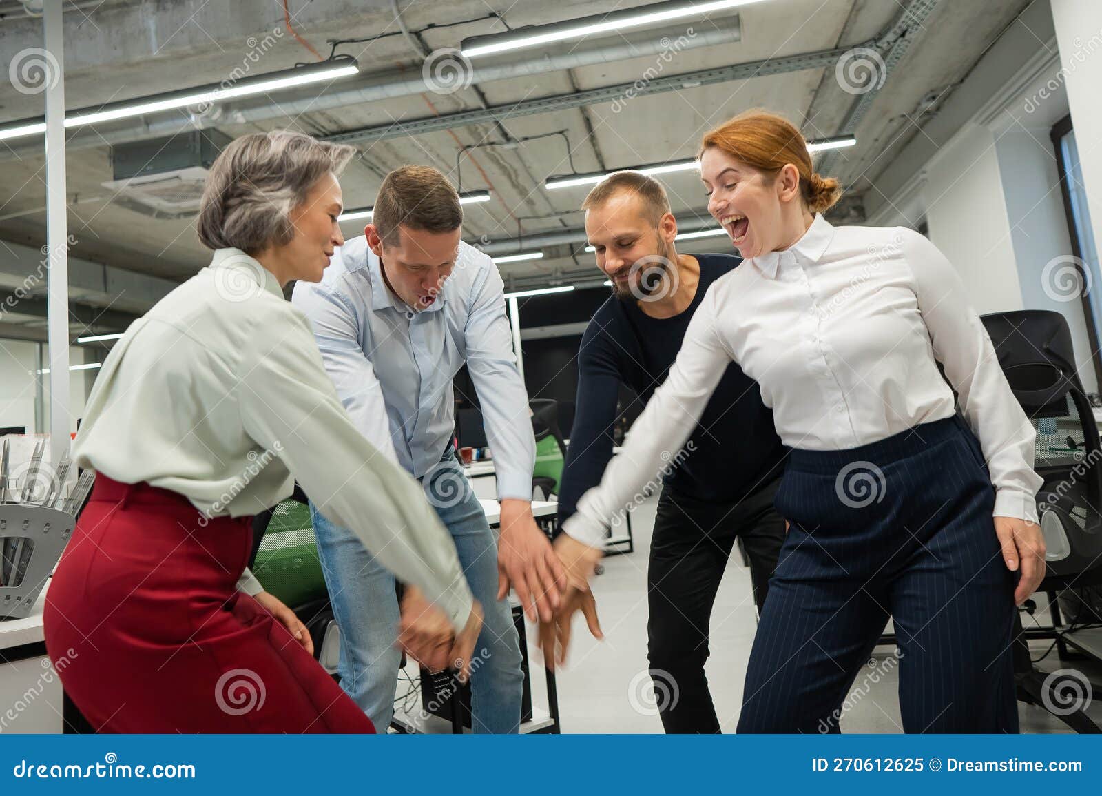Four Colleagues Give the Low Five in the Office. Stock Image - Image of ...