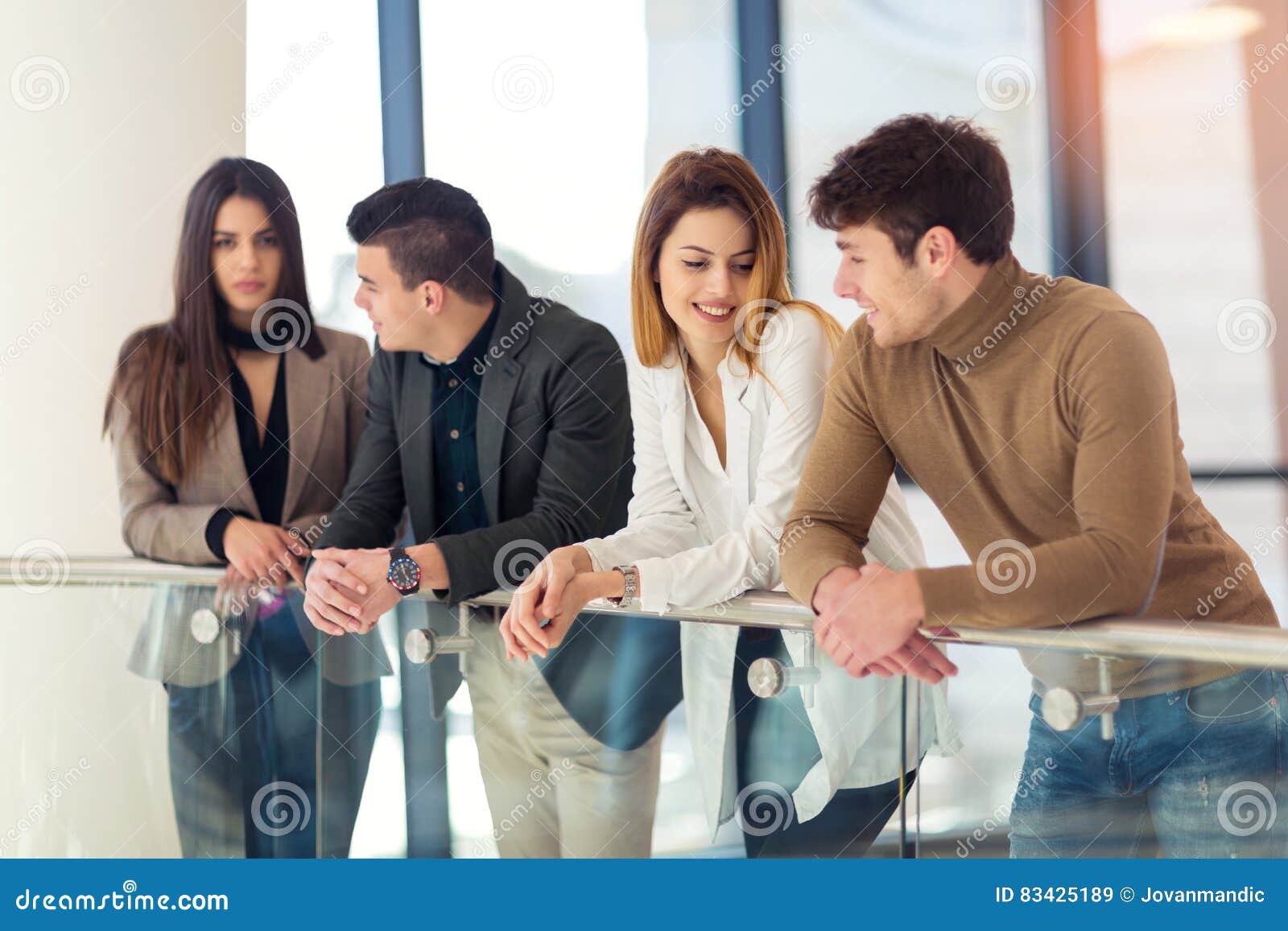 Four Colleagues Talking in the Hall Office Building Stock Image - Image ...