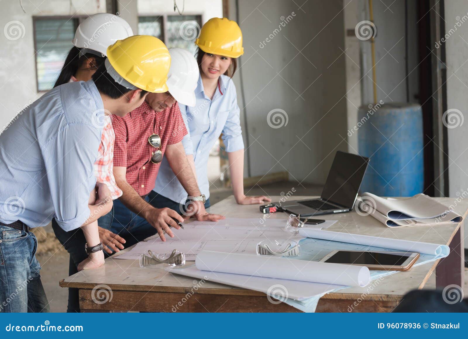Four Construction Engineer Working on Blue Print in Side Building Plan ...