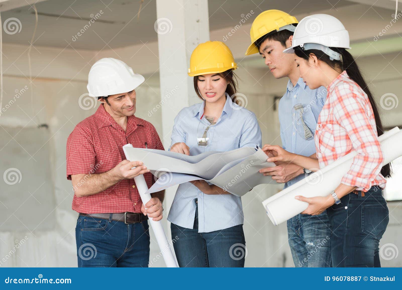 Four Construction Engineer Working in Side Building Plan for Renovation ...