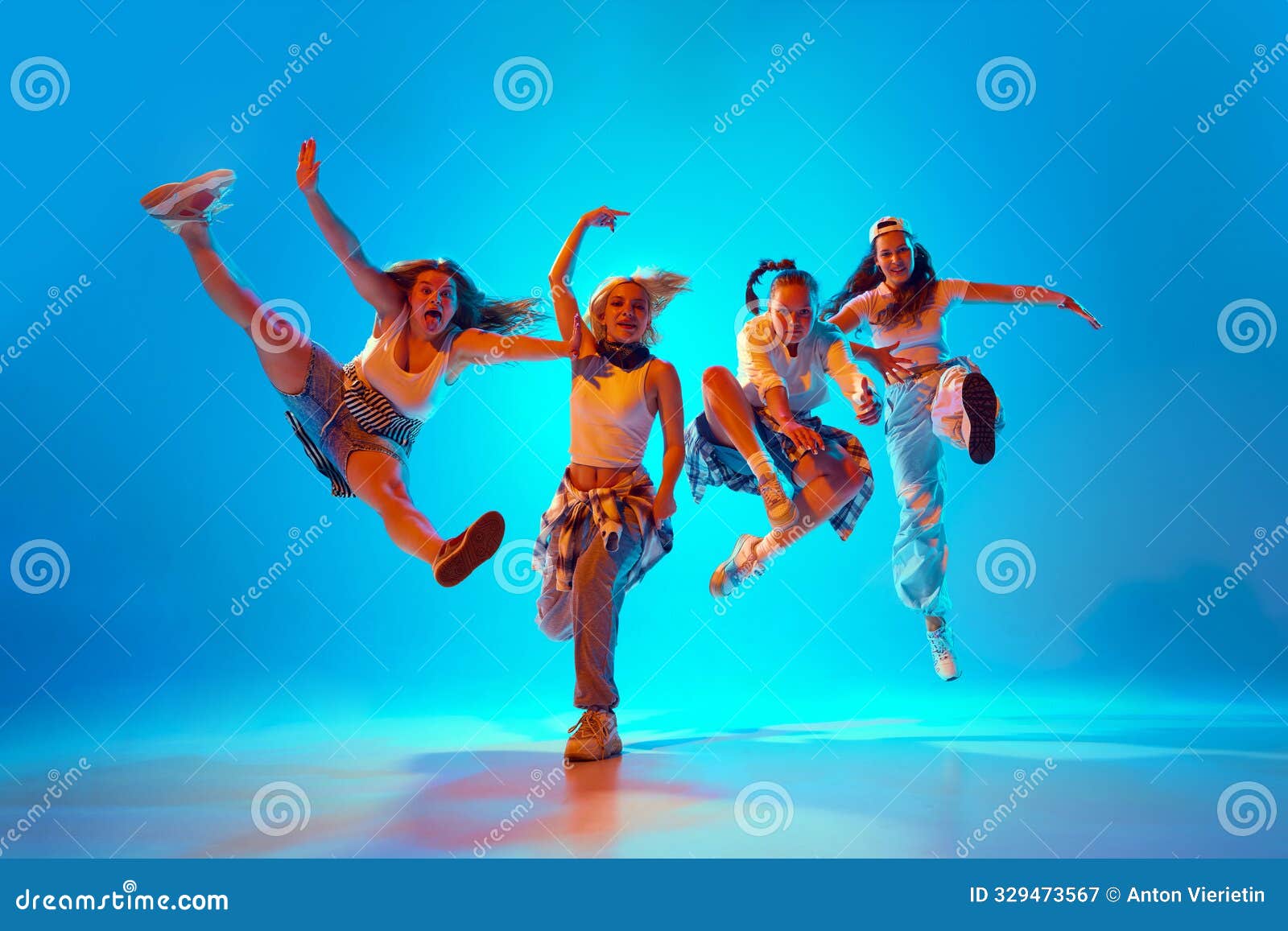 Four Dancers Leap into Air with Exuberant and Dynamic Poses in Vibrant ...