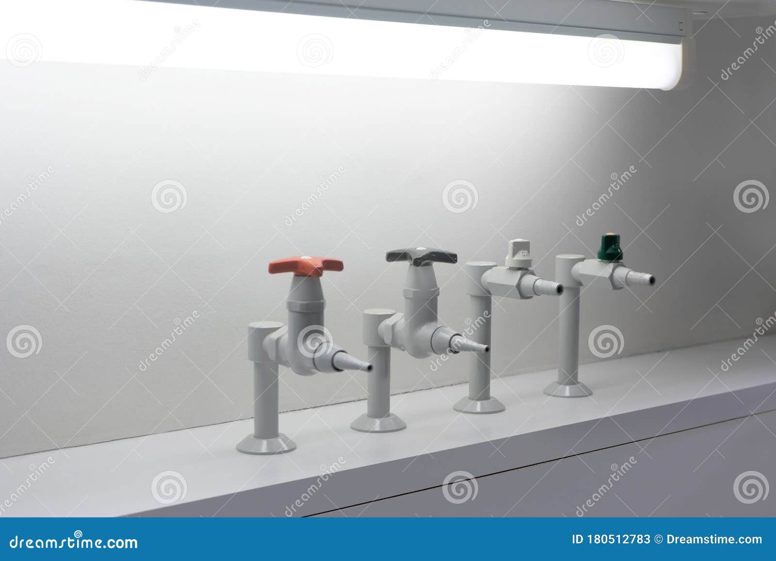 Four Different Colored Fluid Taps in a Laboratory. Hospital Concept ...