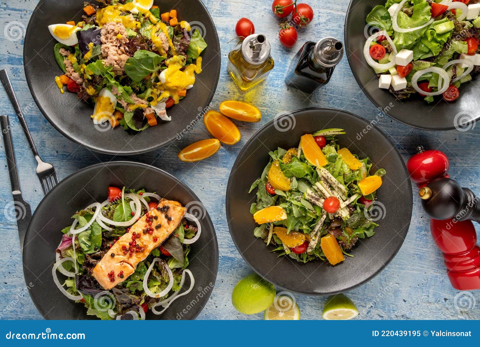 Four Different Types of Salads Served Freshly on Blue Stone Table Stock ...