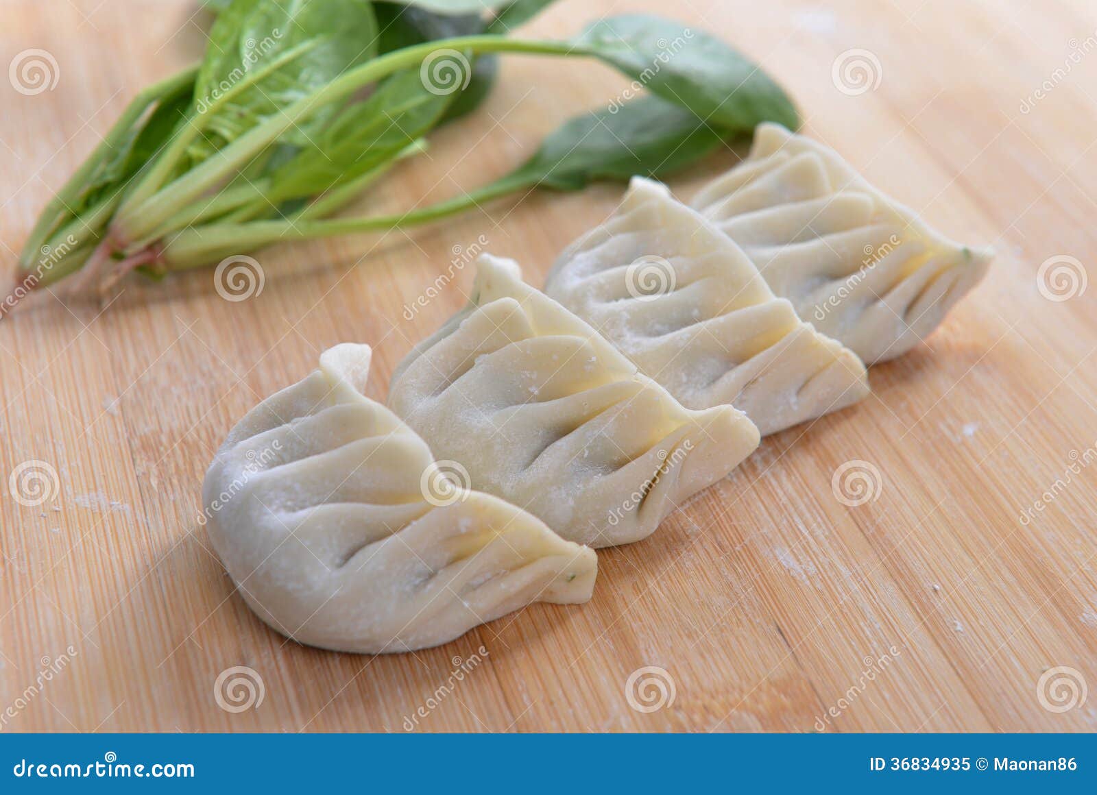 Four dumplings and spinach stock image. Image of meal - 36834935