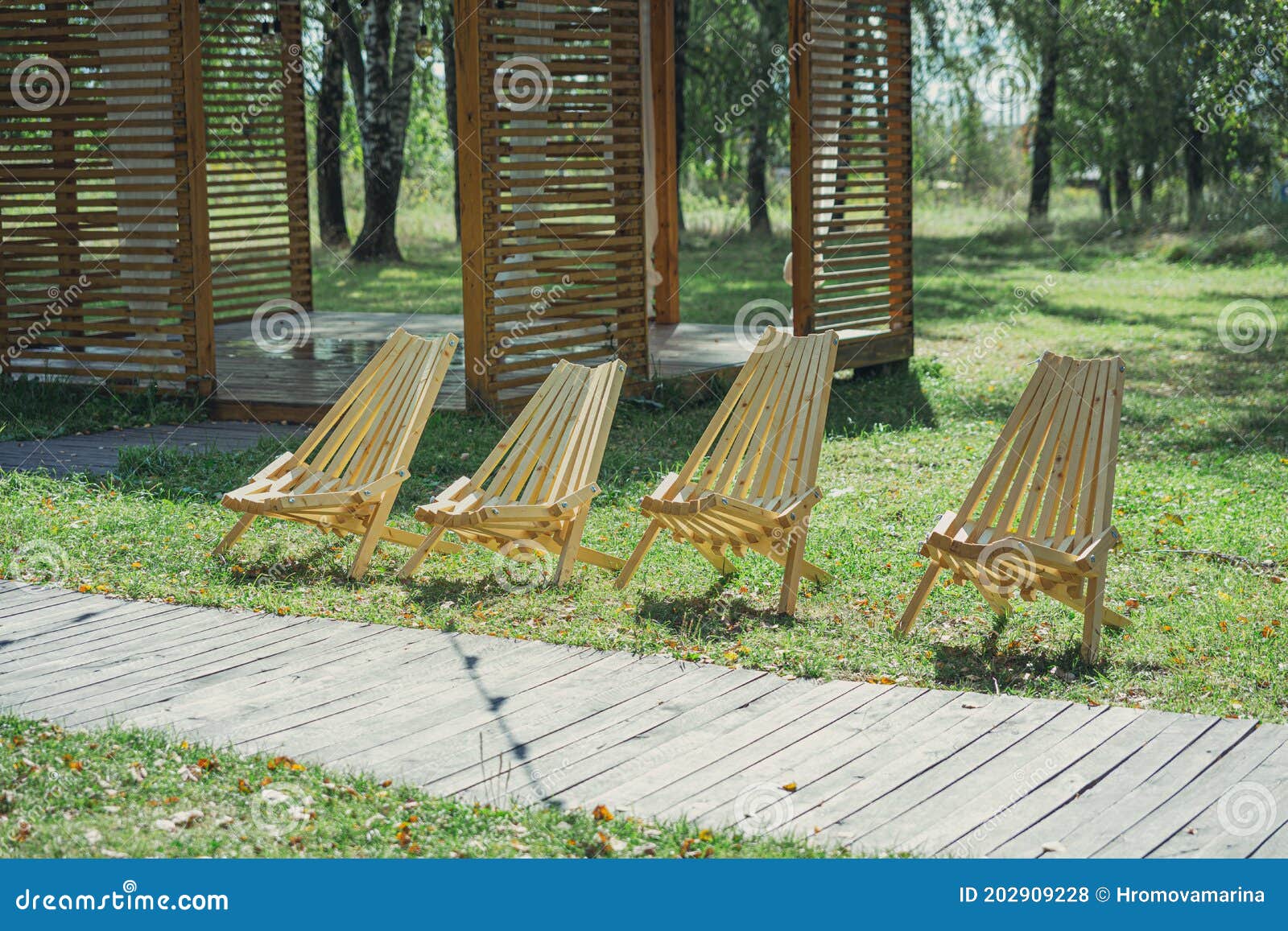 Four Empty Wooden Deck Chairs in the Garden Stock Photo - Image of hyde ...