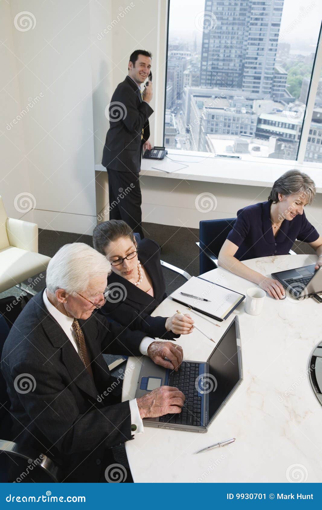 Four Executives Meeting with Laptops in a Conferen Stock Image - Image ...