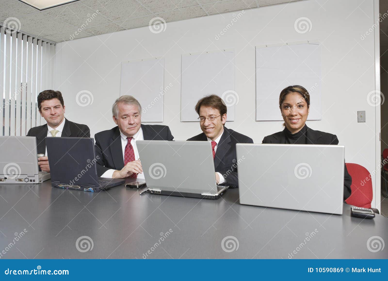 Four Executives Using Laptops. Stock Image - Image of corporate ...